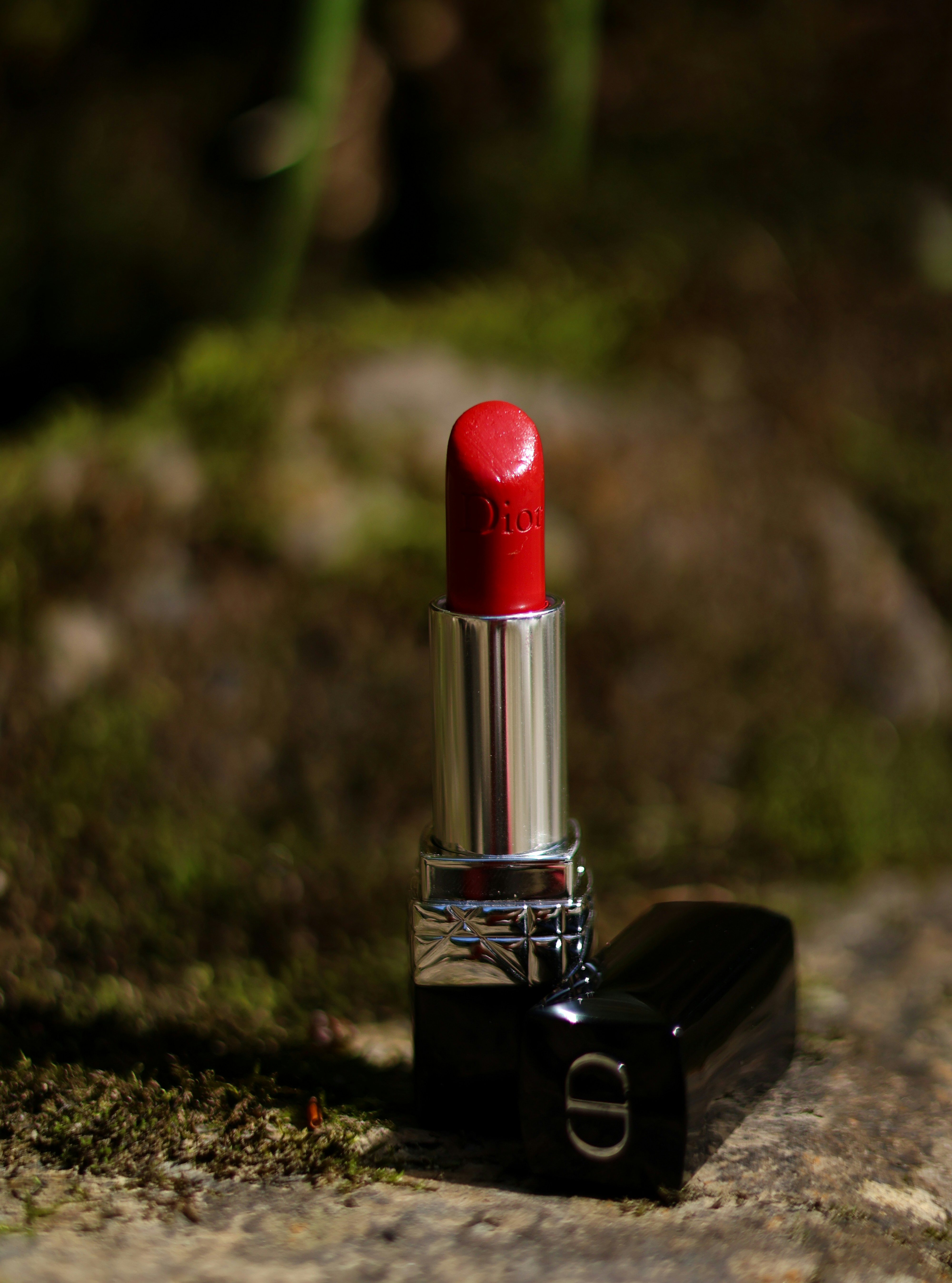 Crimson Dior Lipstick on a Weathered Concrete Stage