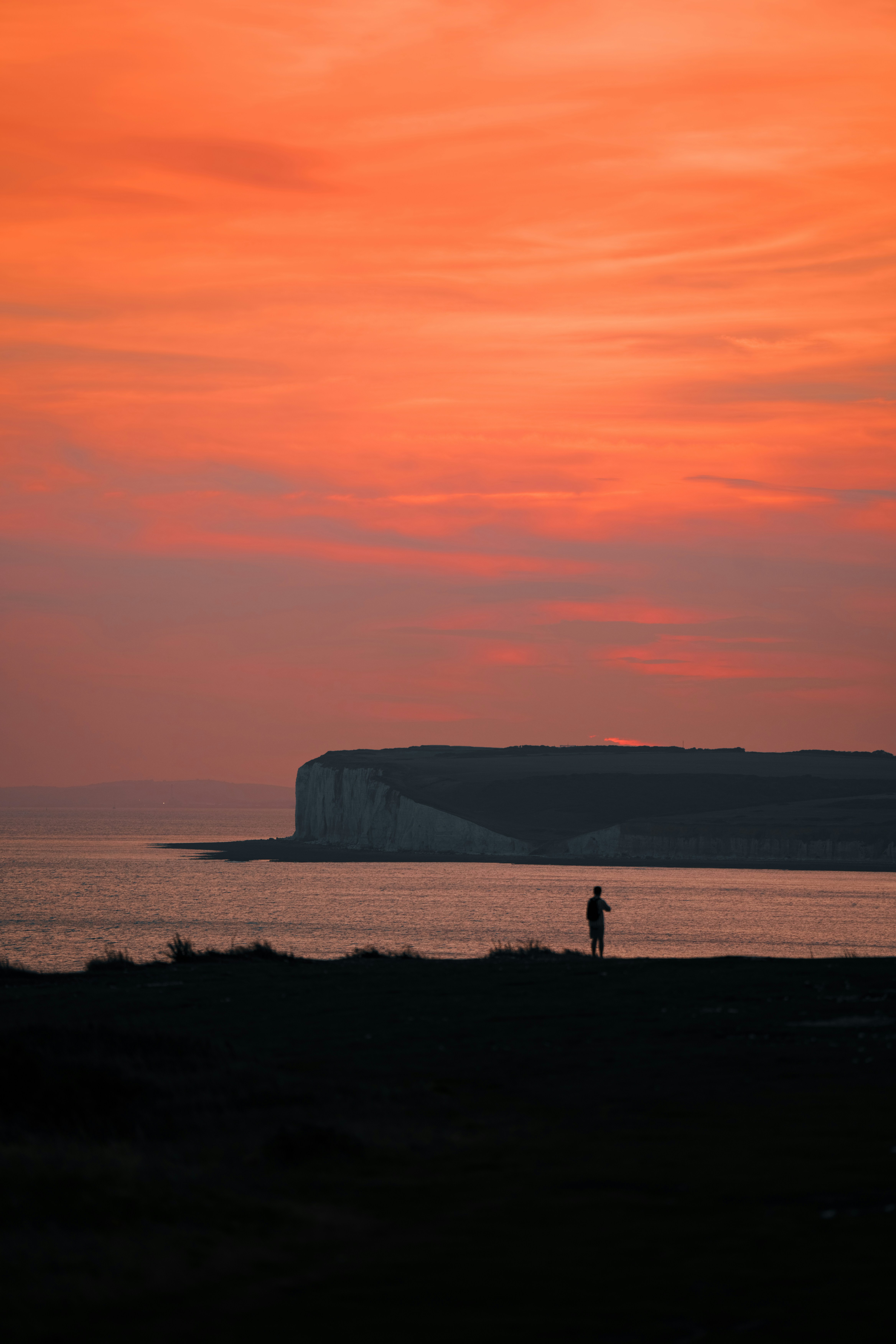 A person standing on a beach watching the sunset photo – Free Black ...