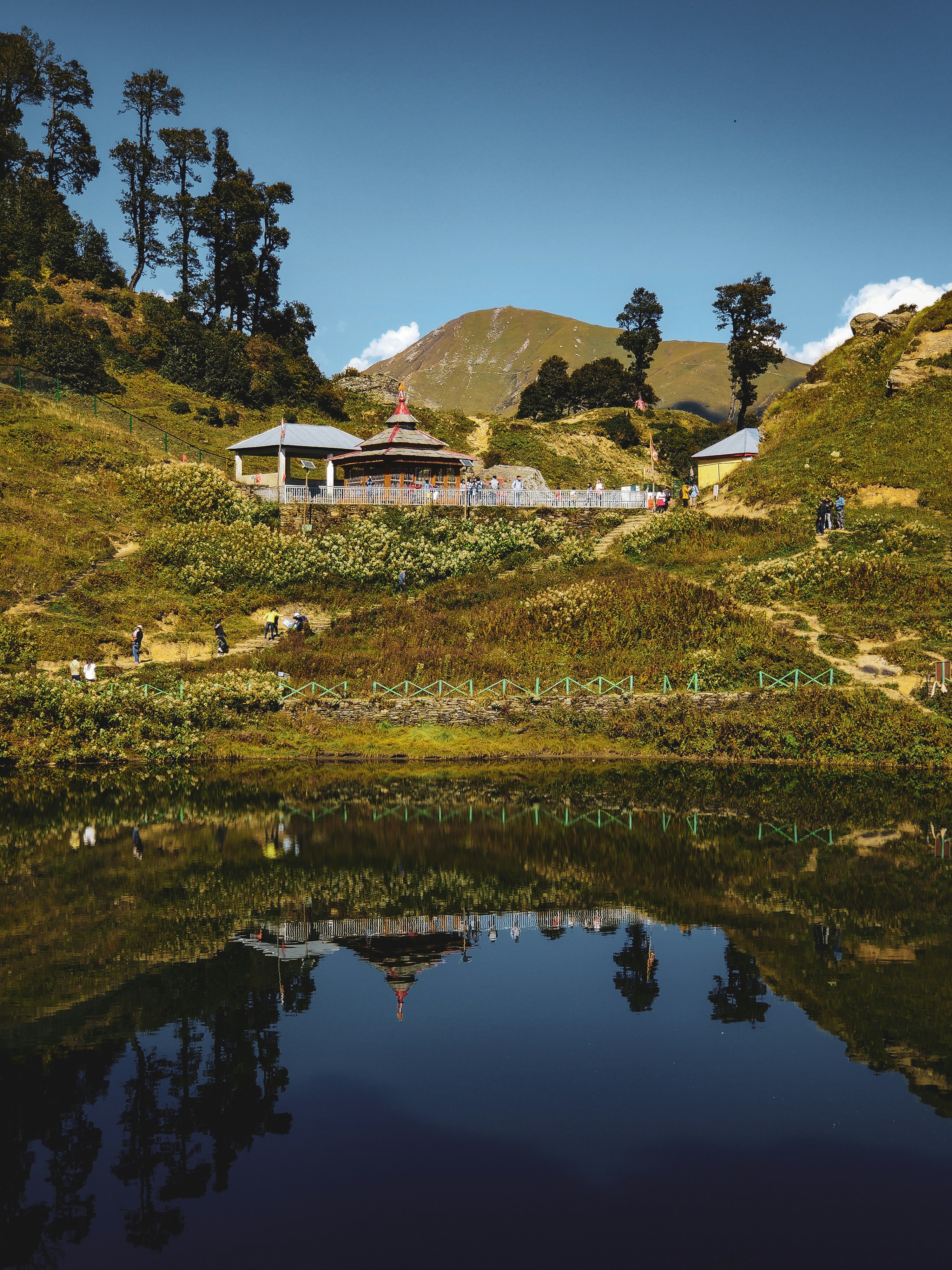 A house sitting on a hill next to a body of water photo – Free Himachal ...