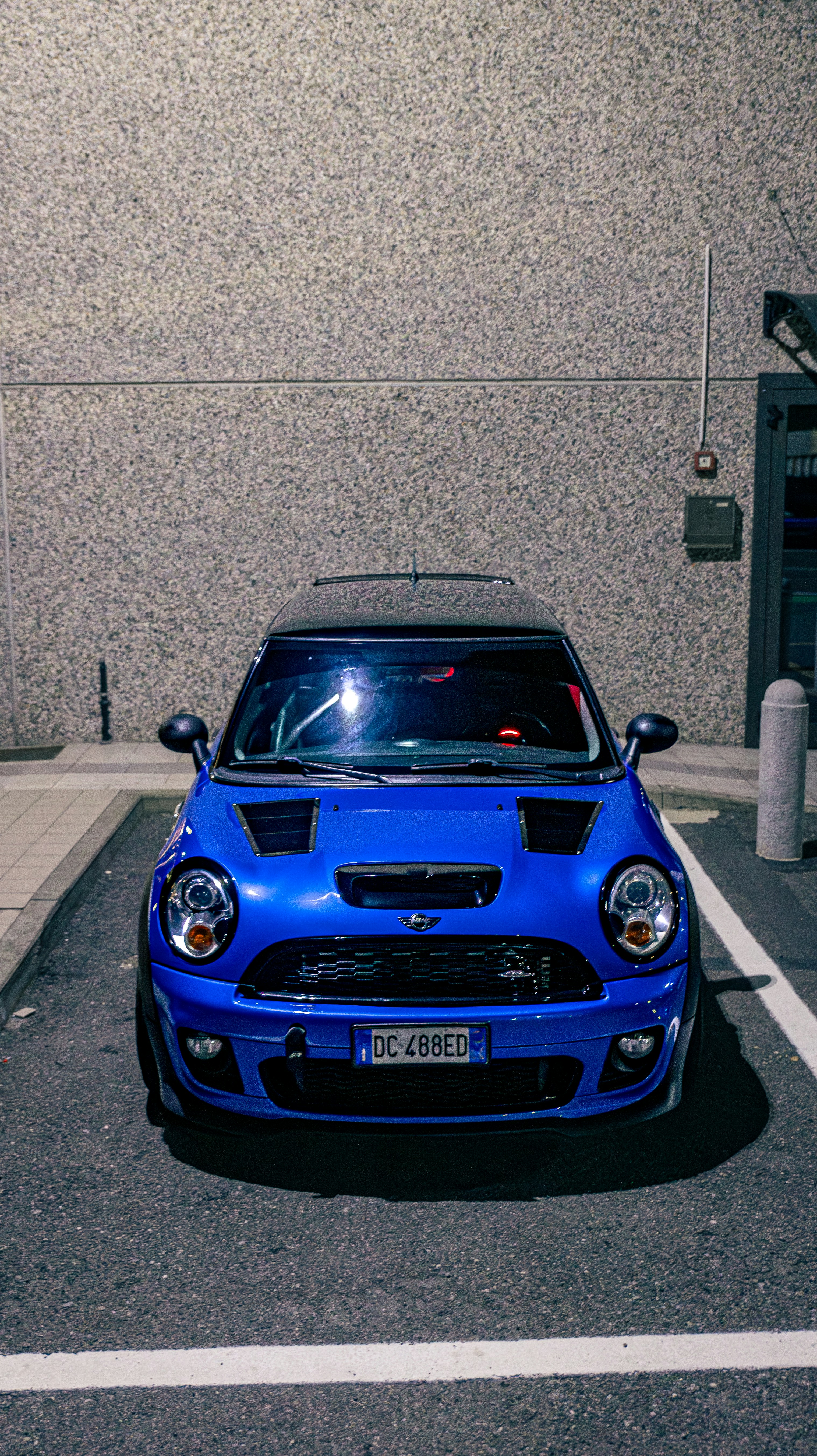 Front-and-Center Neon-Blue Mini Cooper Against a Speckled Granite Backdrop