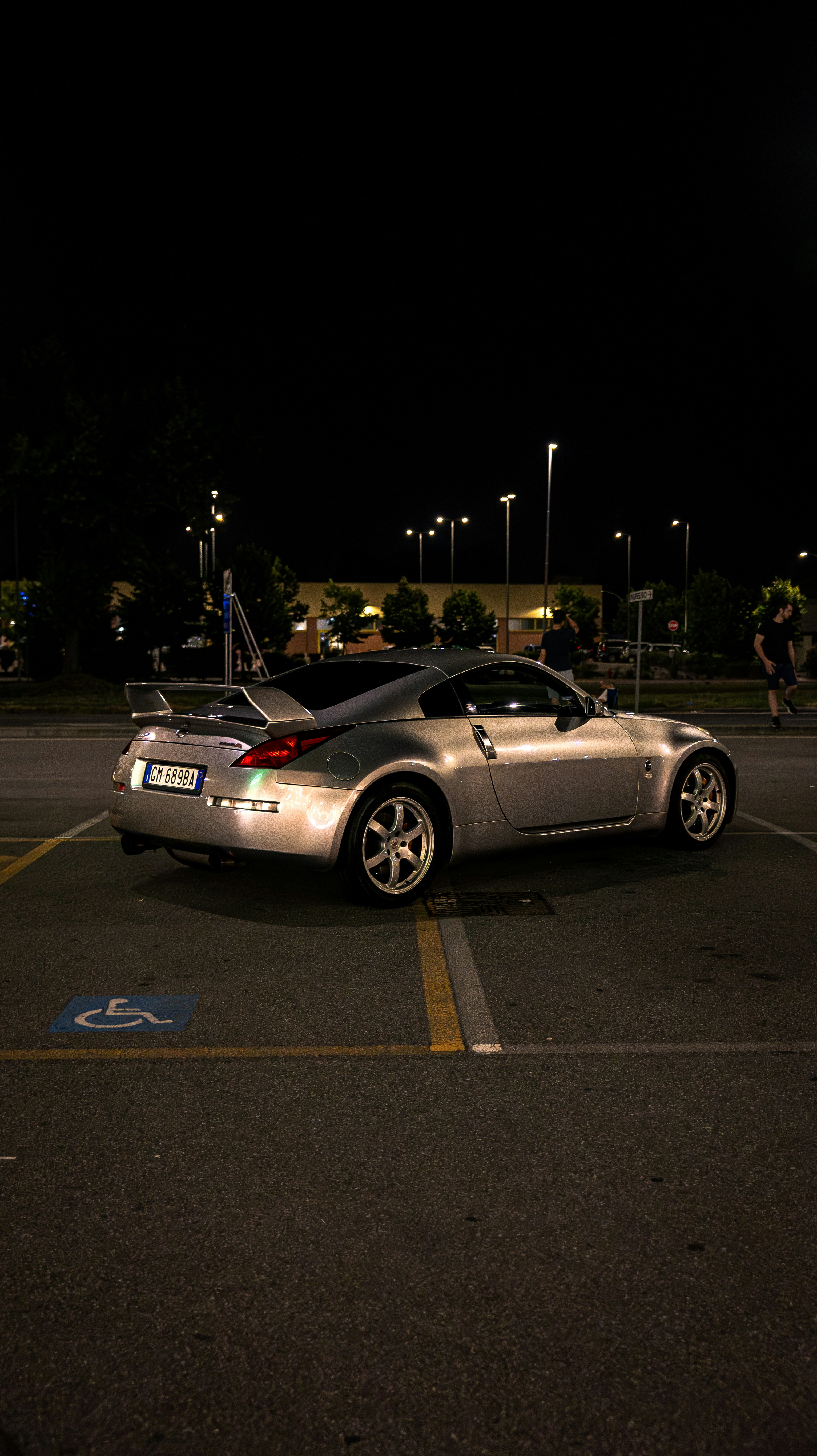 Night Shimmer: Silver Porsche Cabriolet in a Quiet Parking Lot