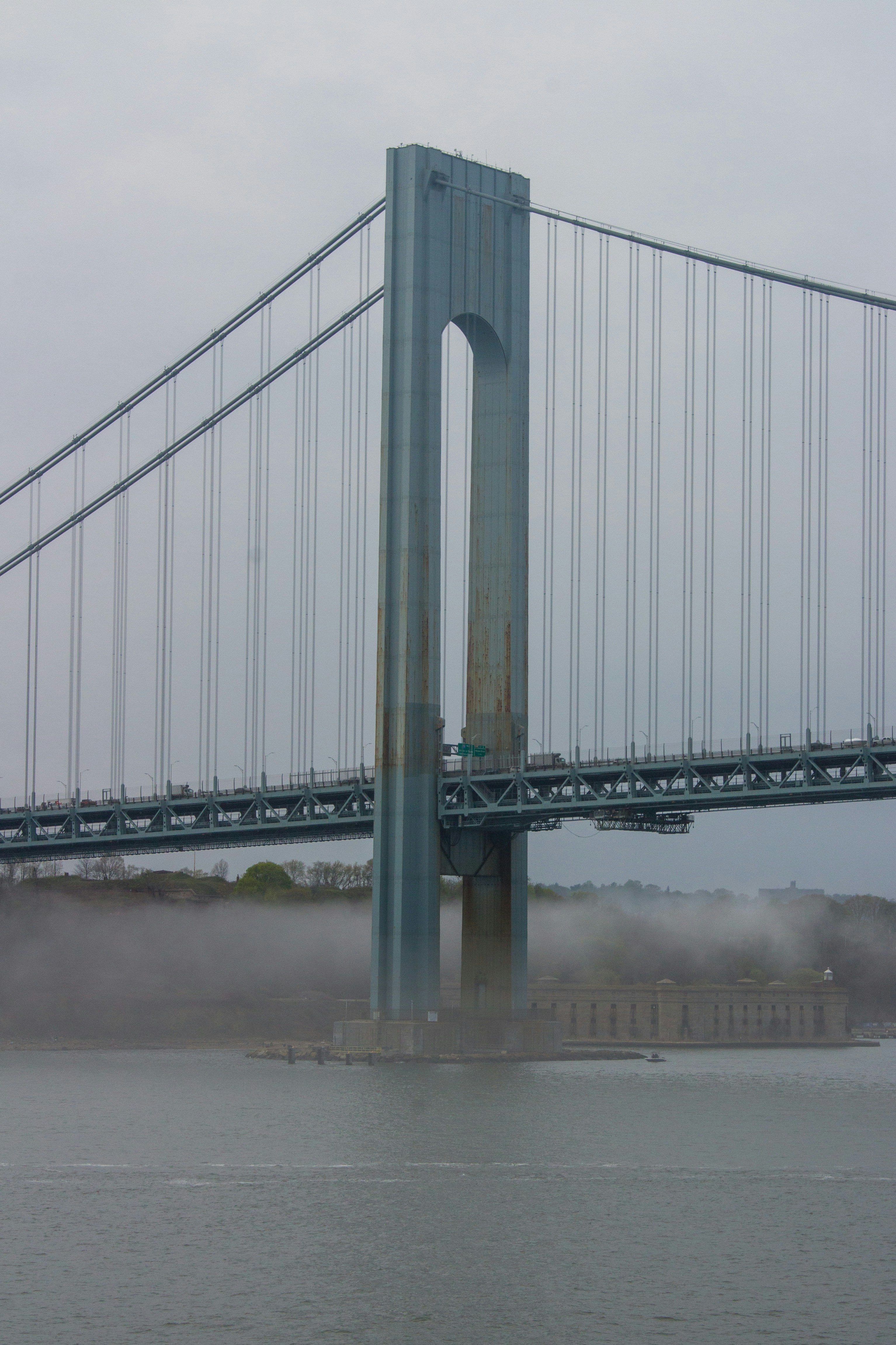 Fogbound Tower: A Suspension Bridge Emerges Through the River Mist