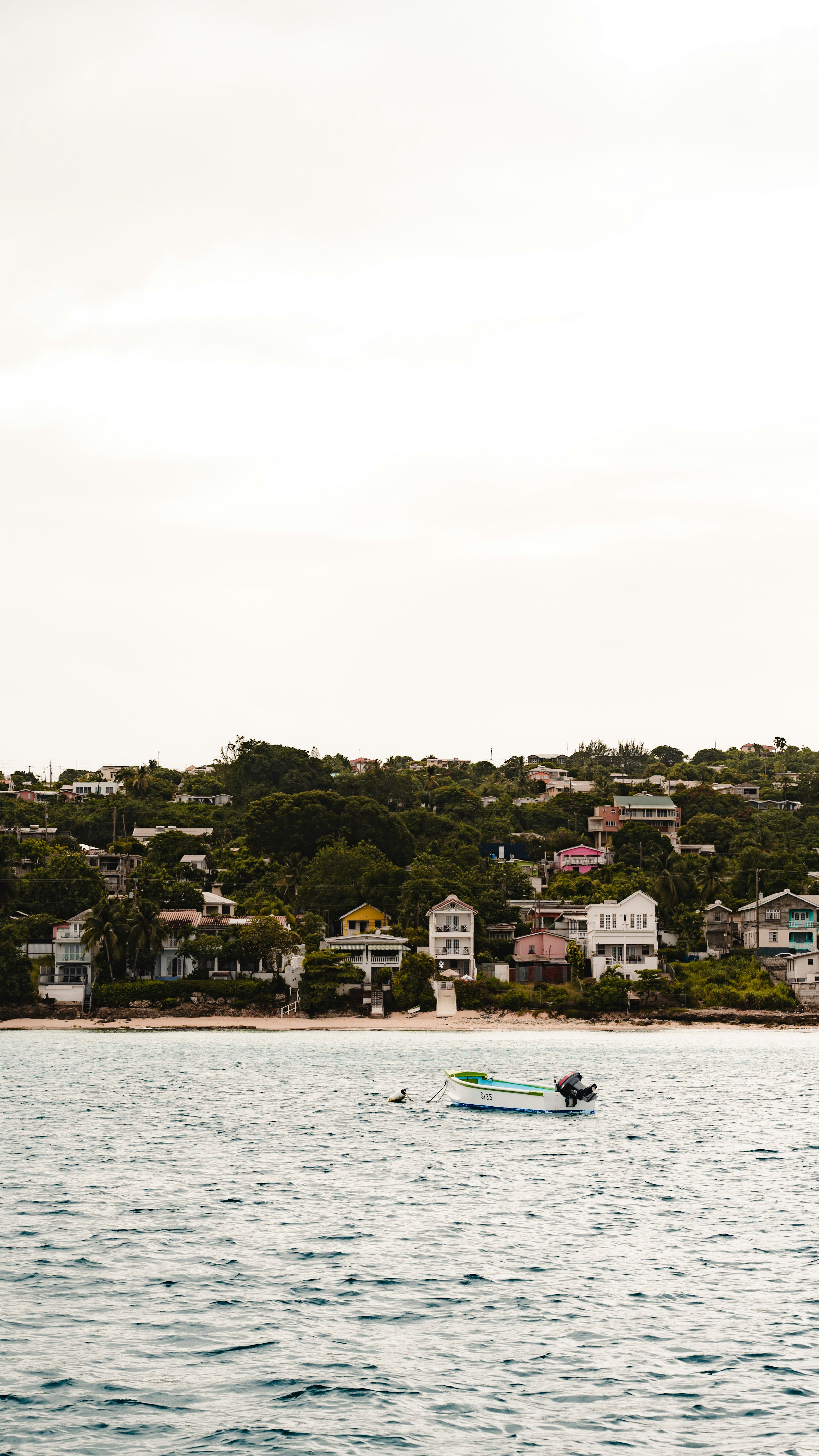 a small boat in the middle of a body of water