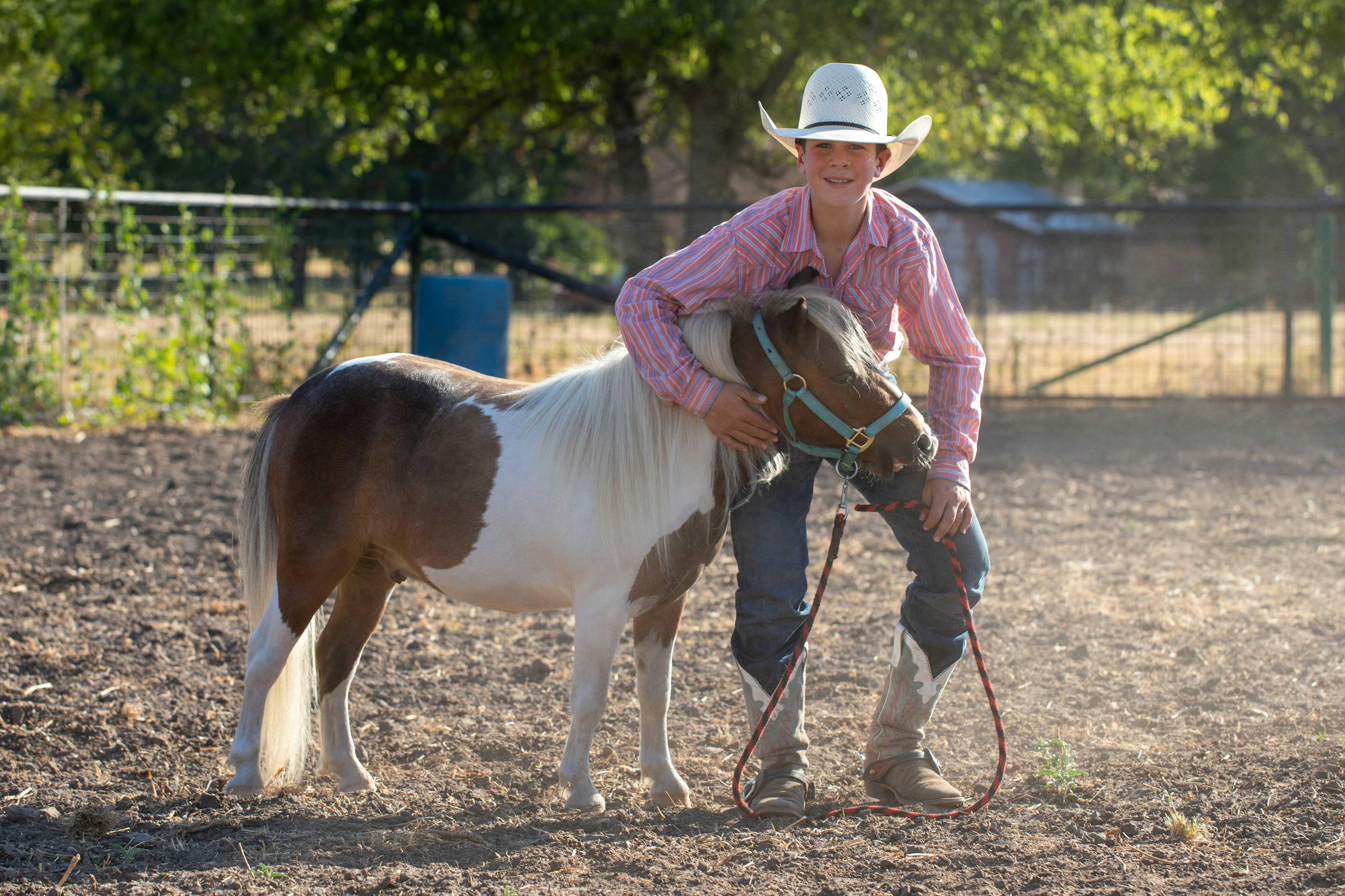 Un homme coiffé d’un chapeau de cow-boy debout à côté d’un cheval photo ...