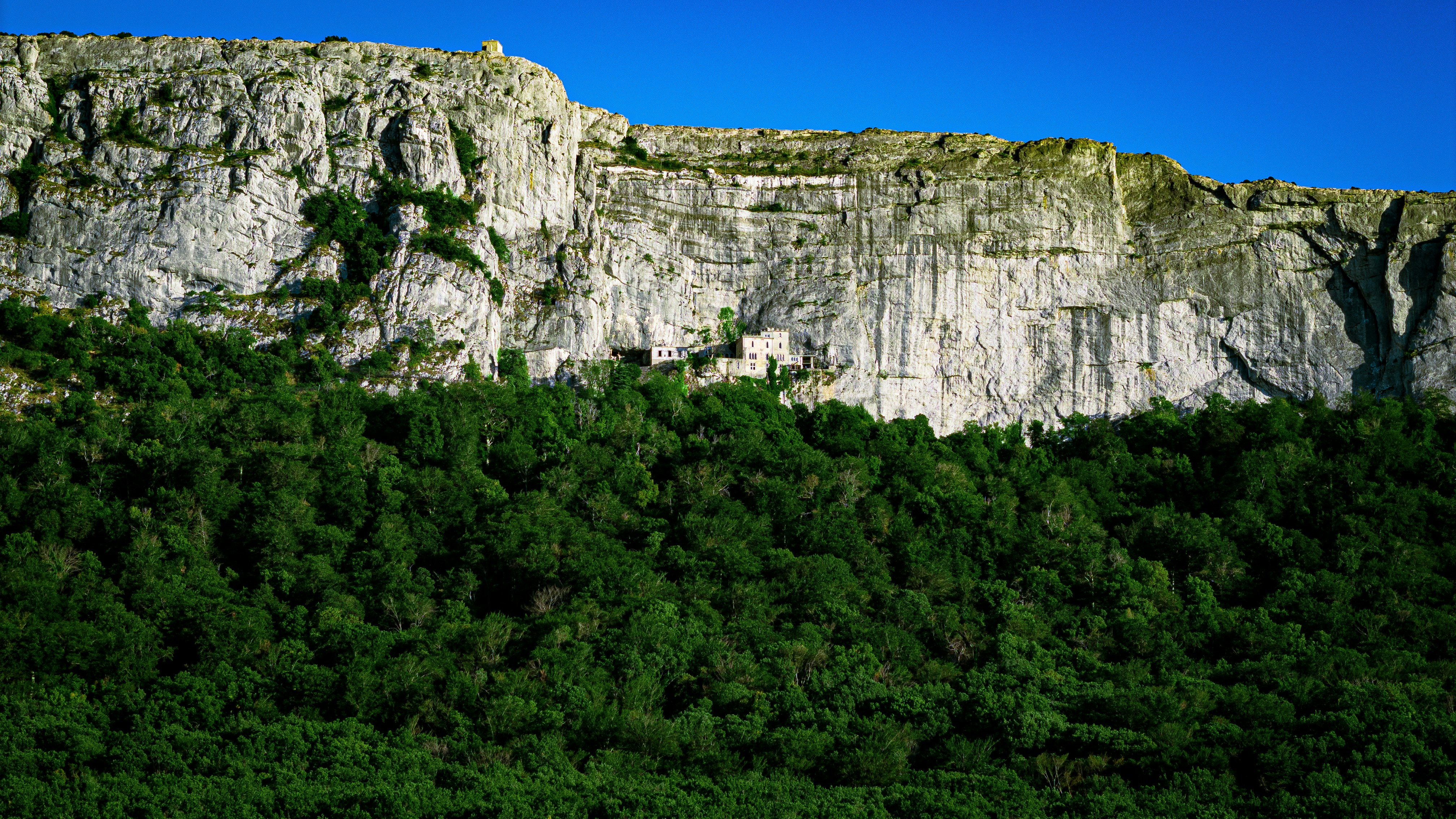 A view of a mountain with trees on the side of it photo – Free Provence ...