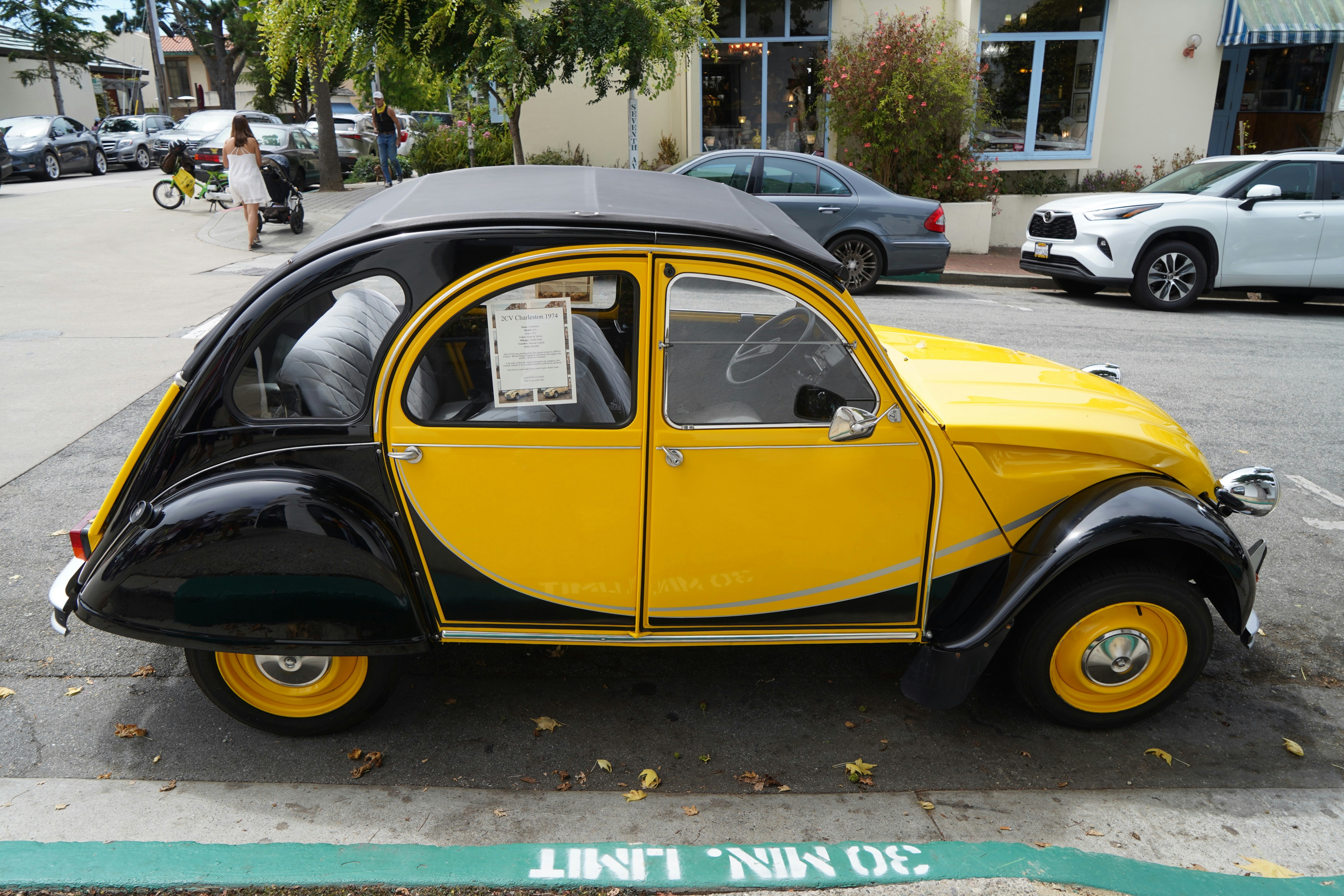 Sunlit Two-Tone: The Citroën 2CV Anchored on a Quiet Street