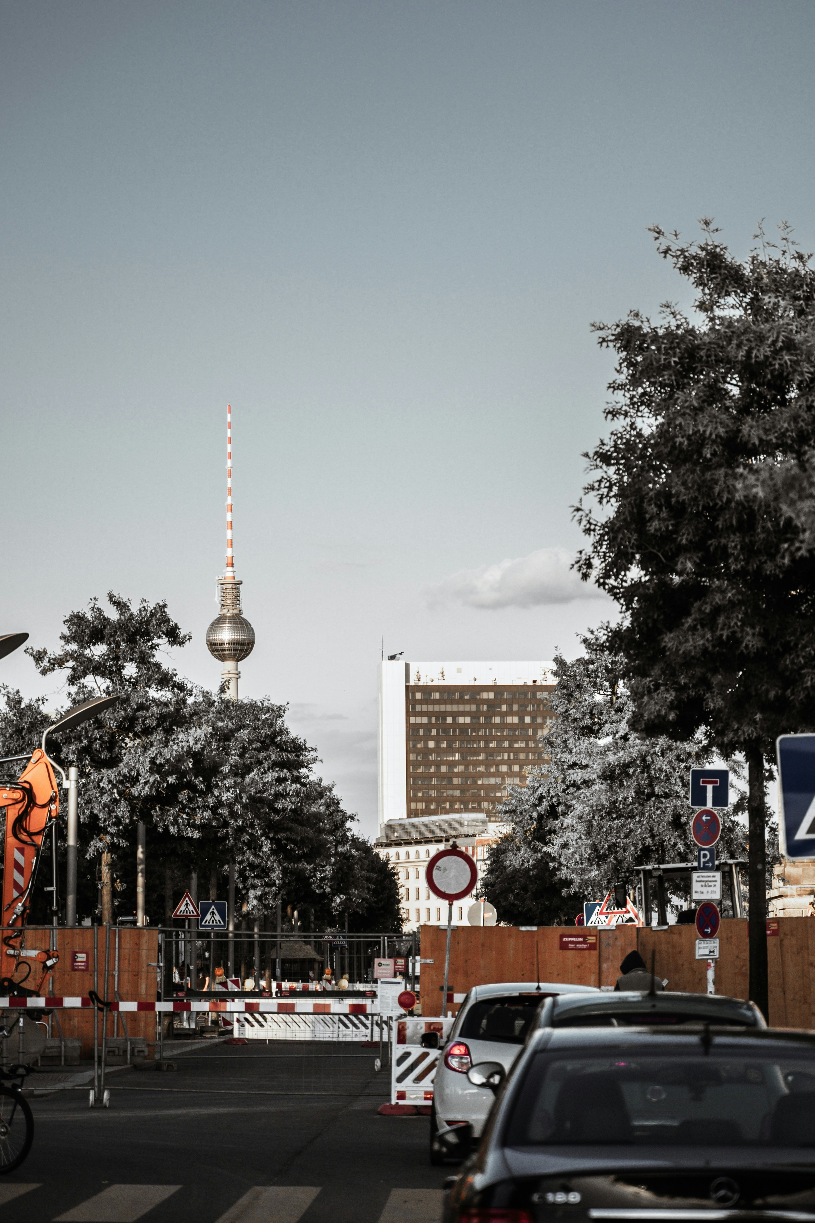 Barrier Horizon: Berlin's Fernsehturm Peeks Through a Construction Street