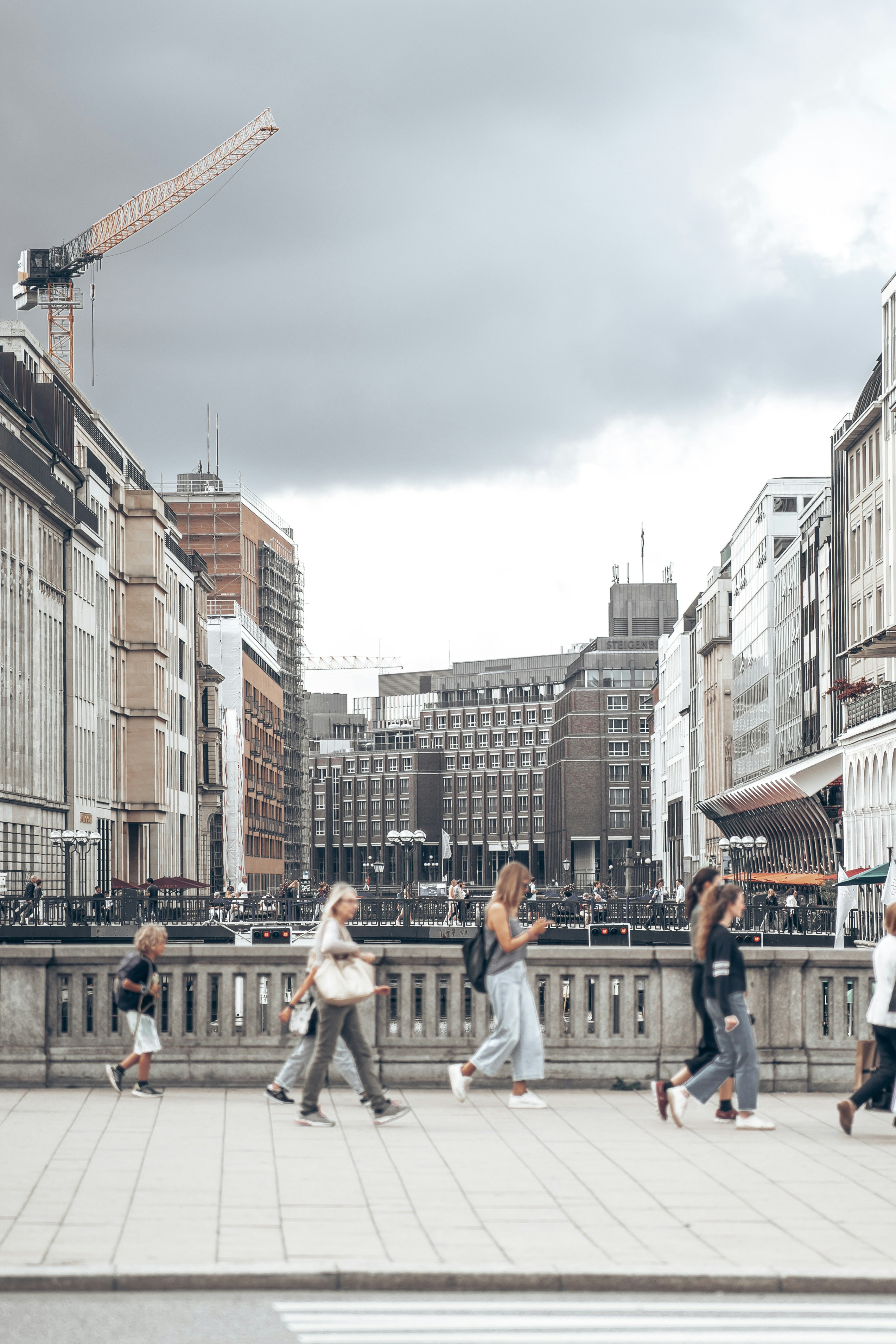A group of people walking across a bridge photo – Free Hamburg Image on ...