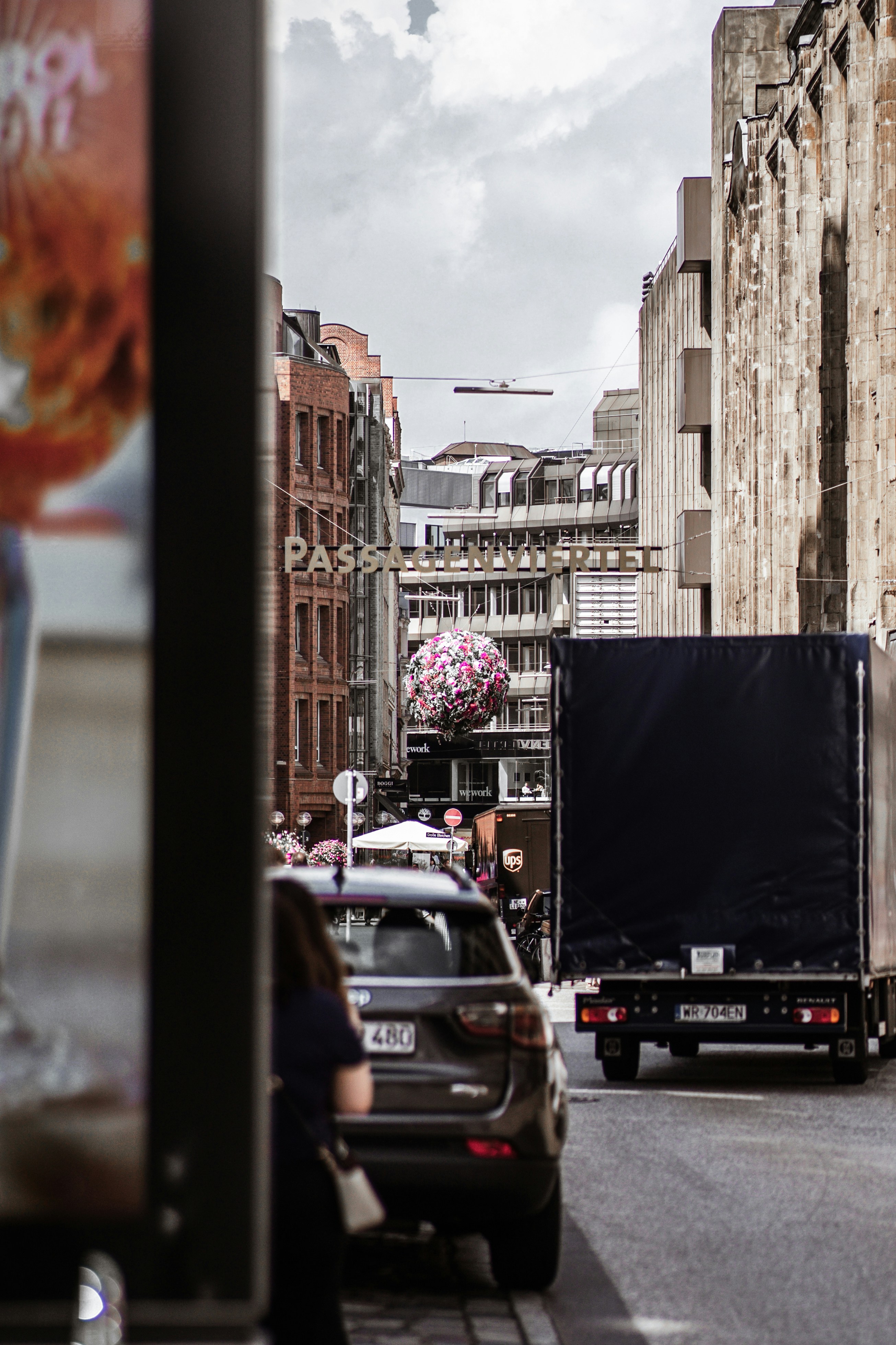 City Street Frame: A Balloon of Blooms and Moving Trucks