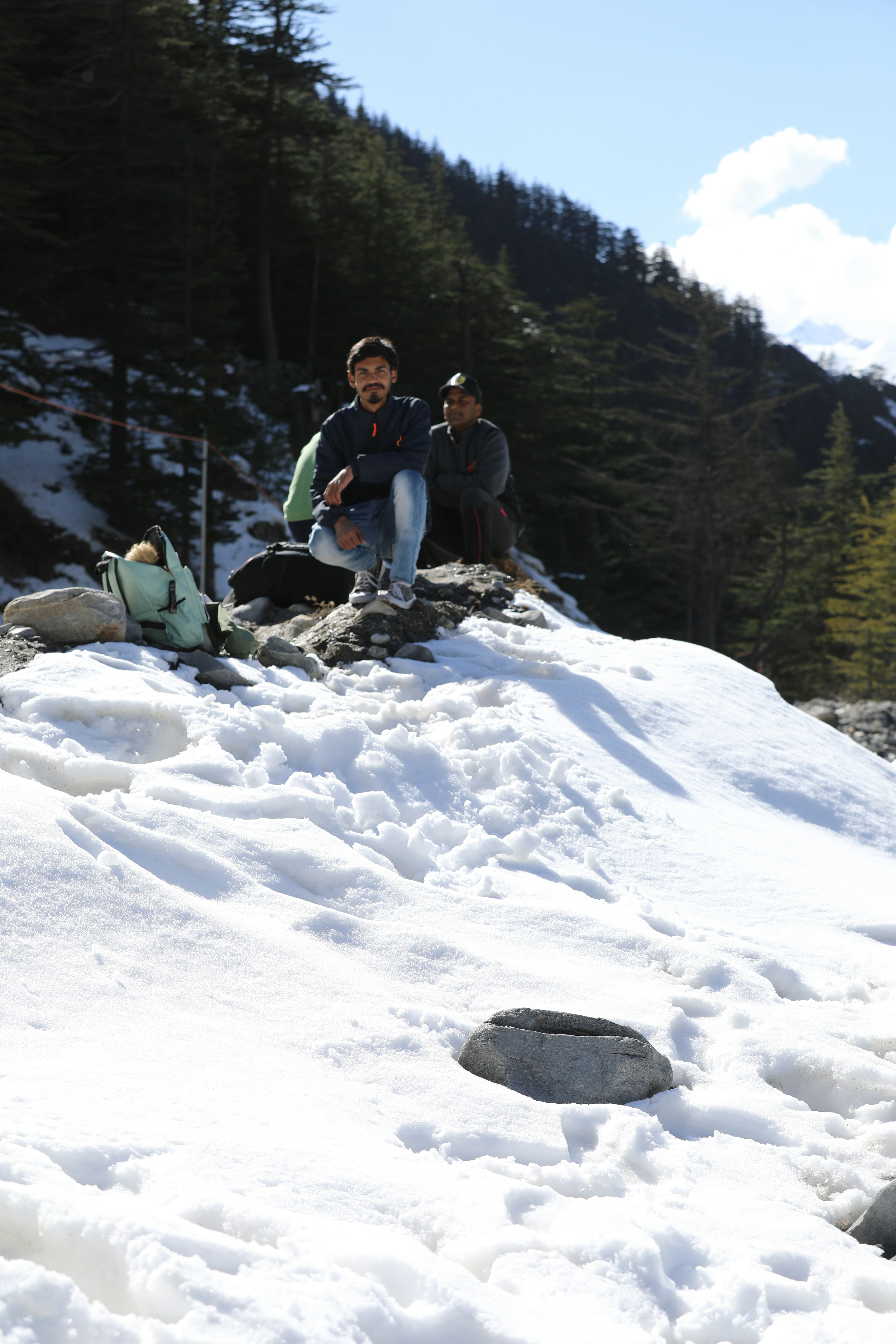 Snowbound Pause: Three Friends atop the Snowy Ridge