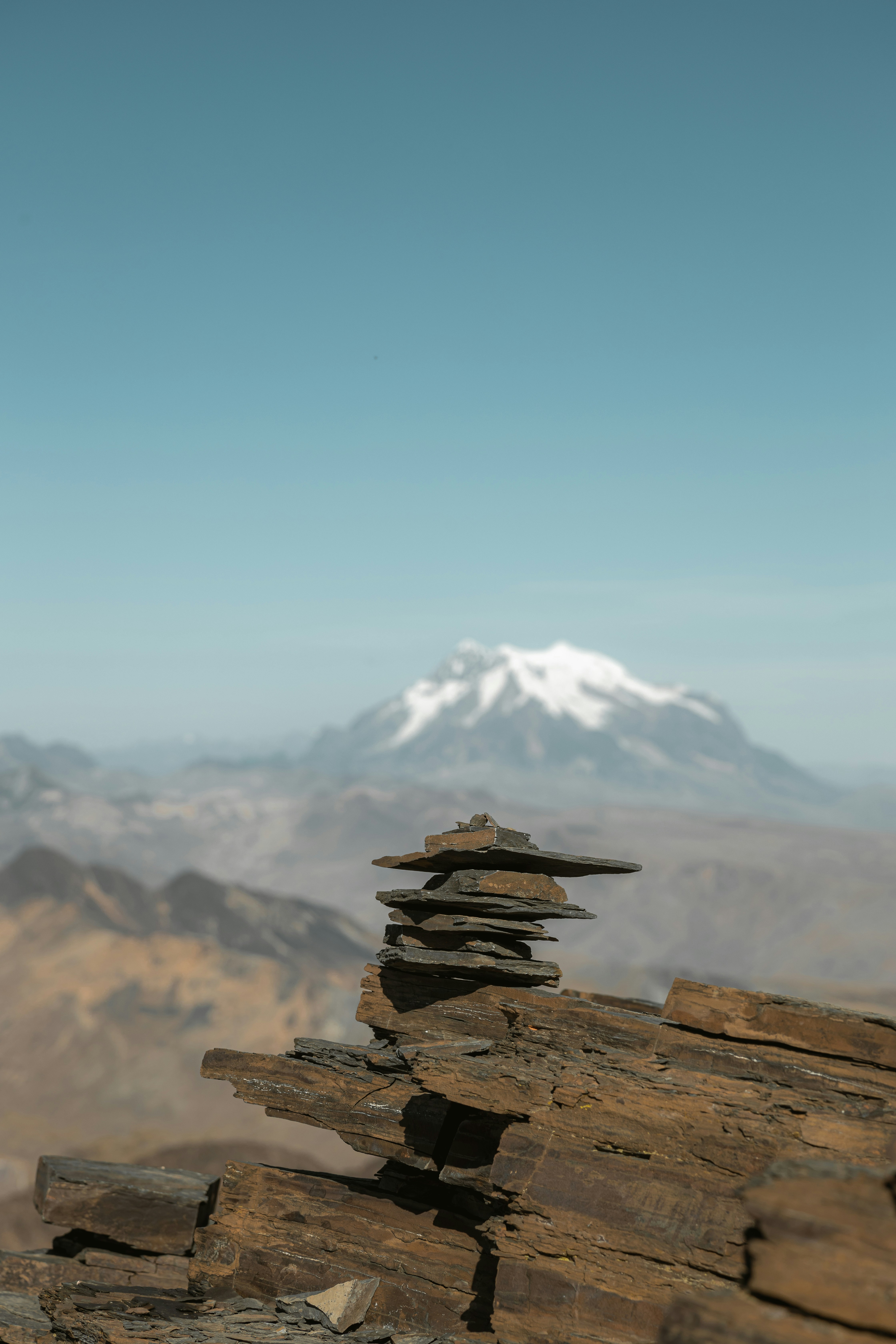 A stack of rocks with a mountain in the background photo – Free ...