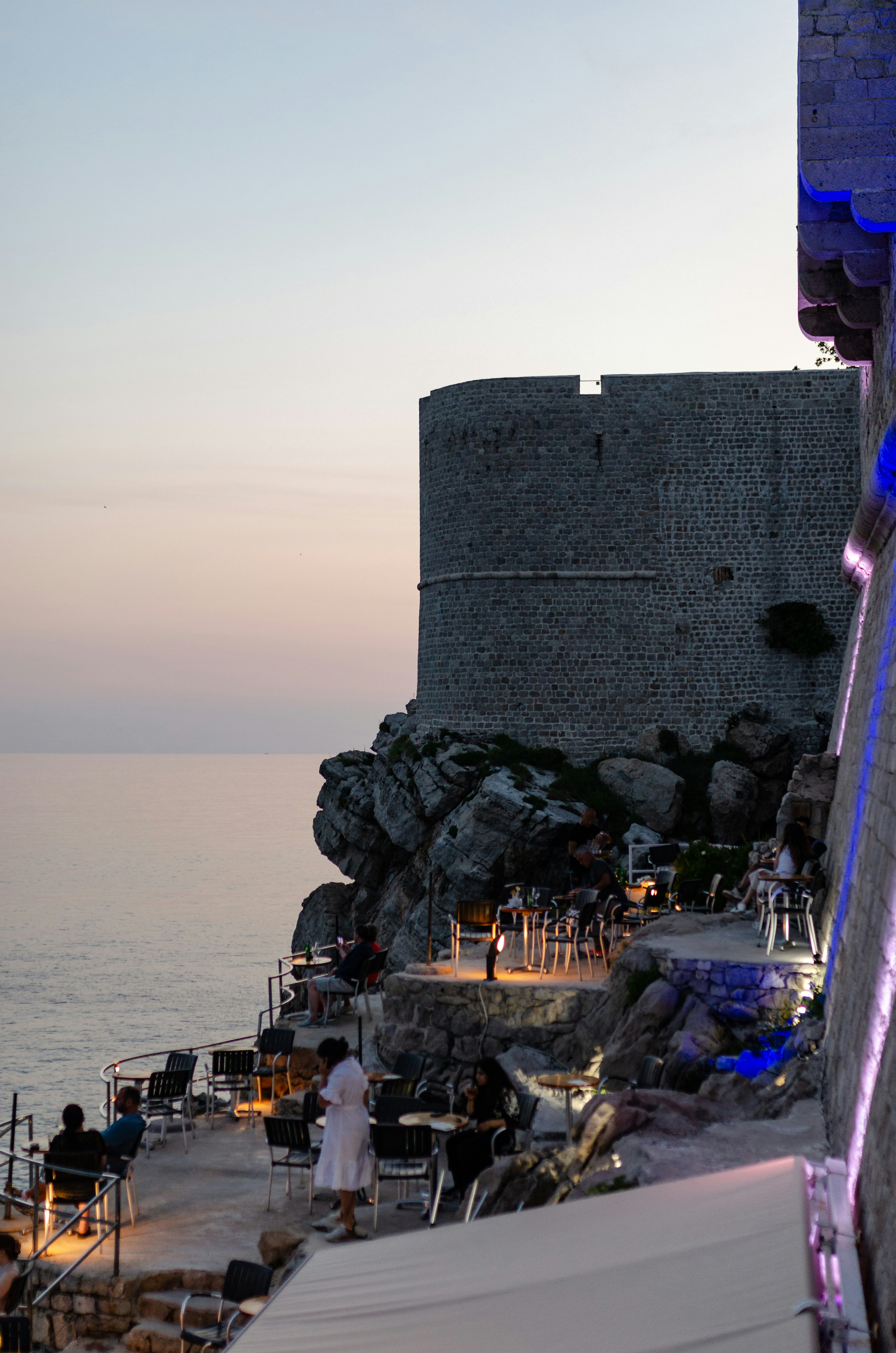 Dusk on the Bastion Terrace: Lantern-lit Bistro by the Cliffside Fortress
