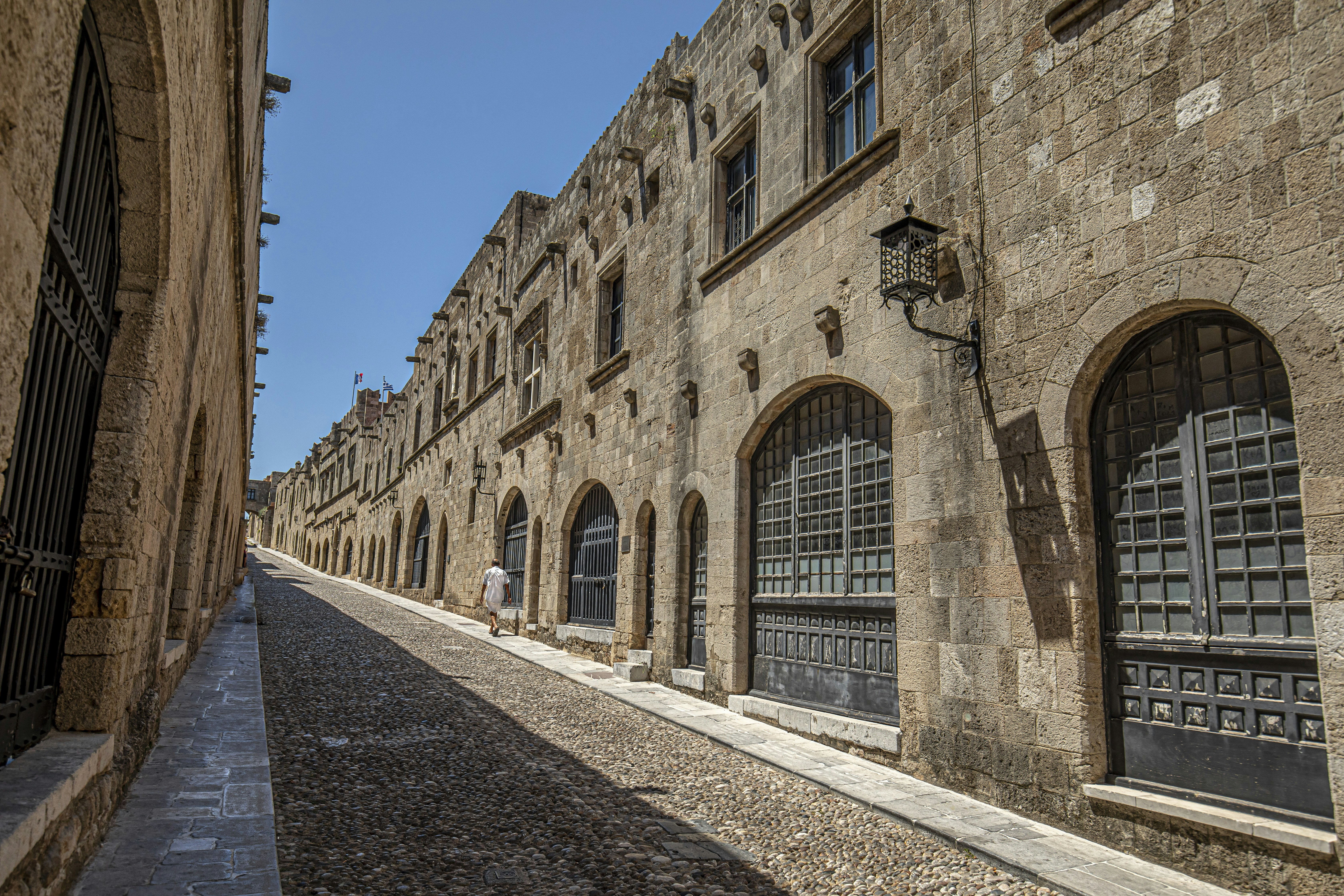 A cobblestone street lined with stone buildings photo – Free Rhodos ...