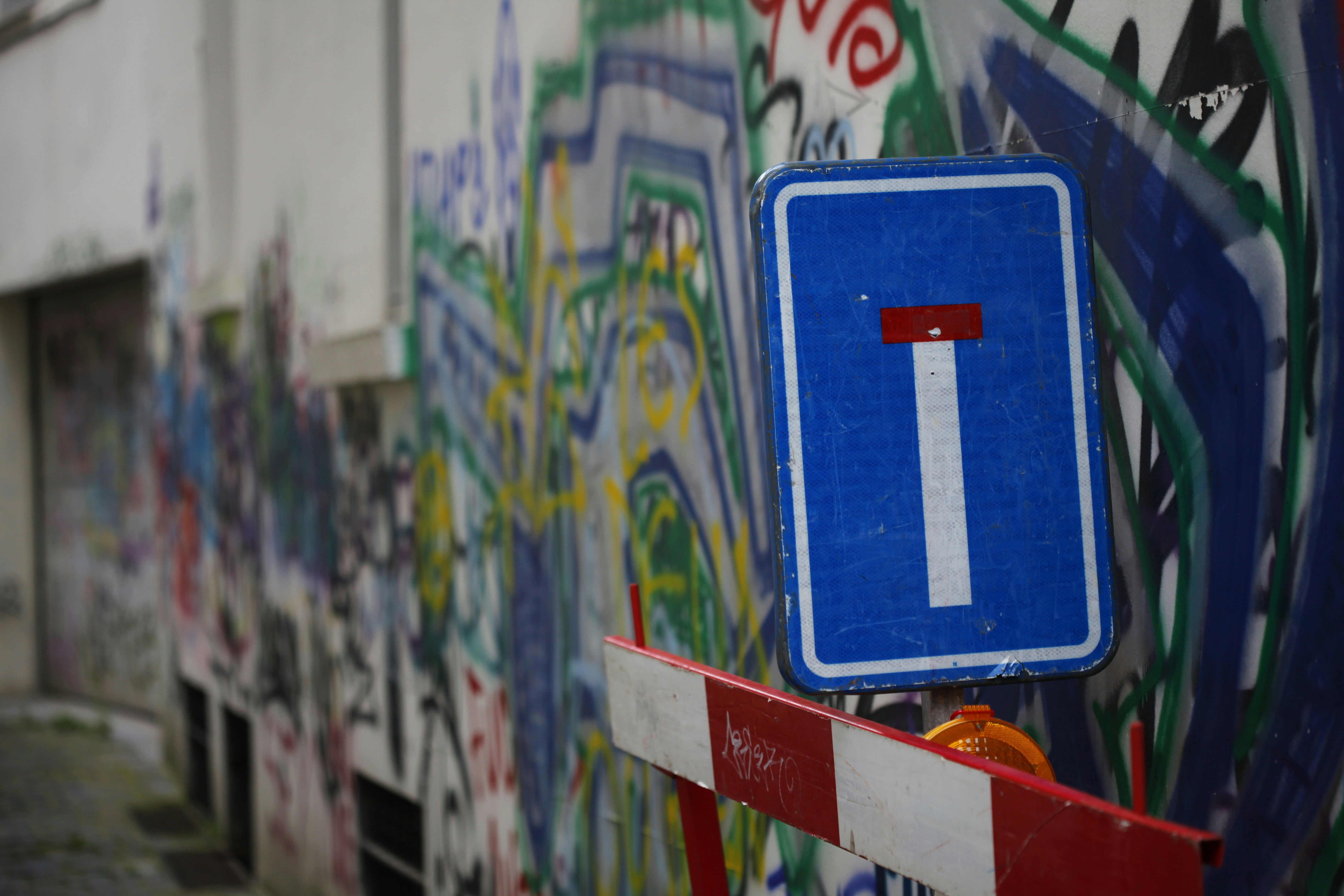 A blue street sign sitting on the side of a wall photo – Free Gent ...