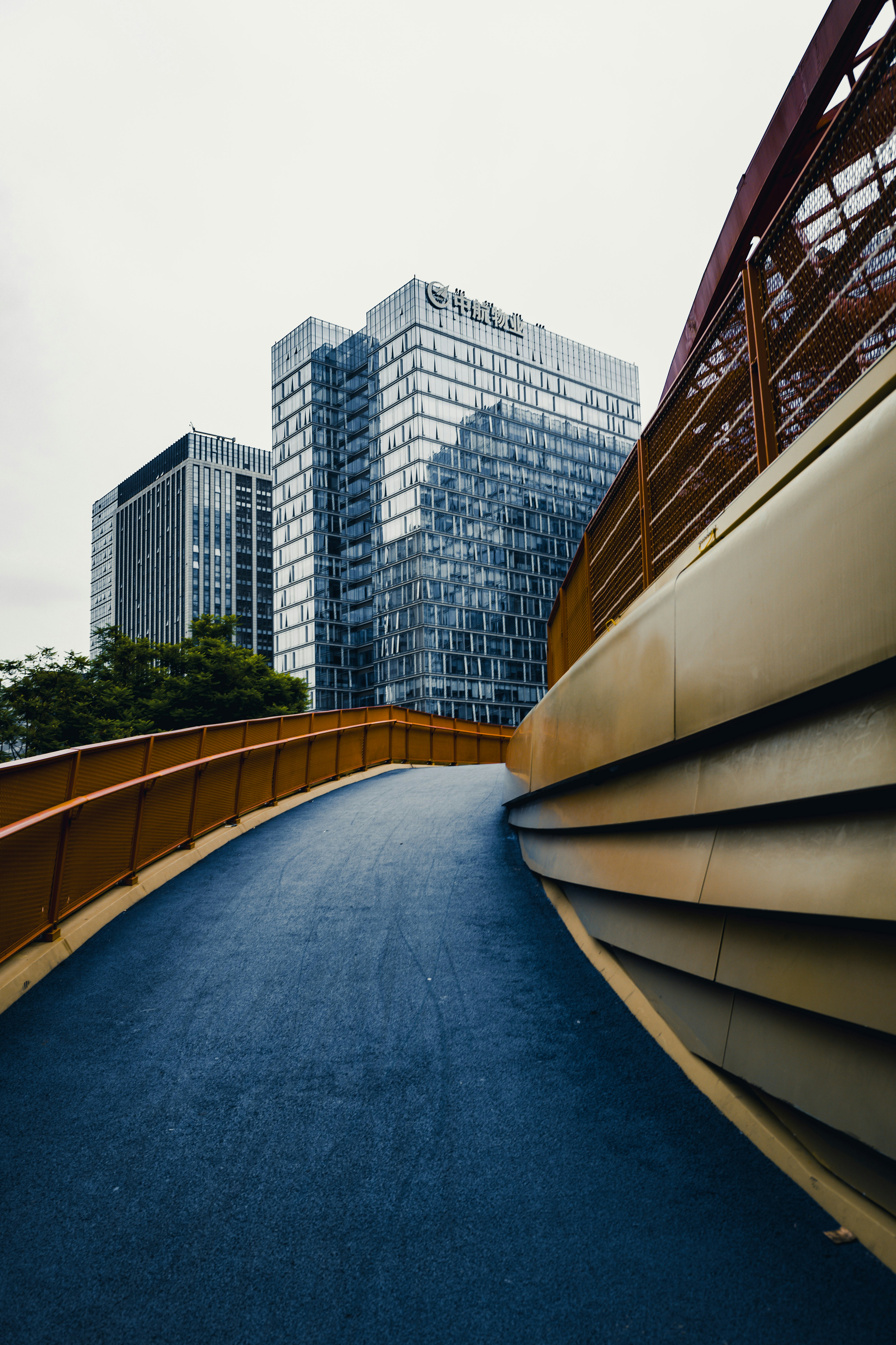 A bridge that has a blue tarmac on it photo – Free Urban Image on Unsplash