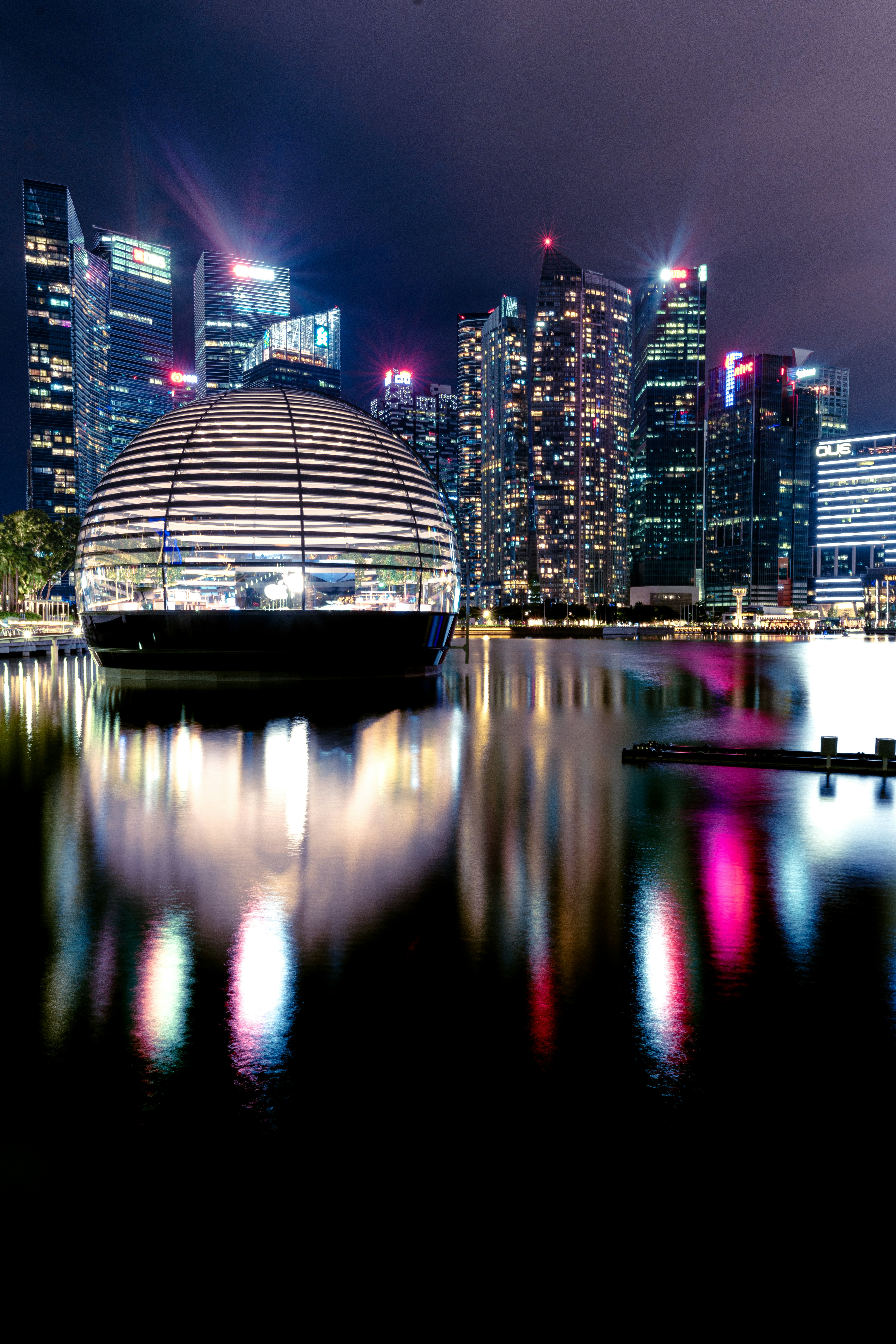 City Sphere: Neon Reflections on Marina at Night
