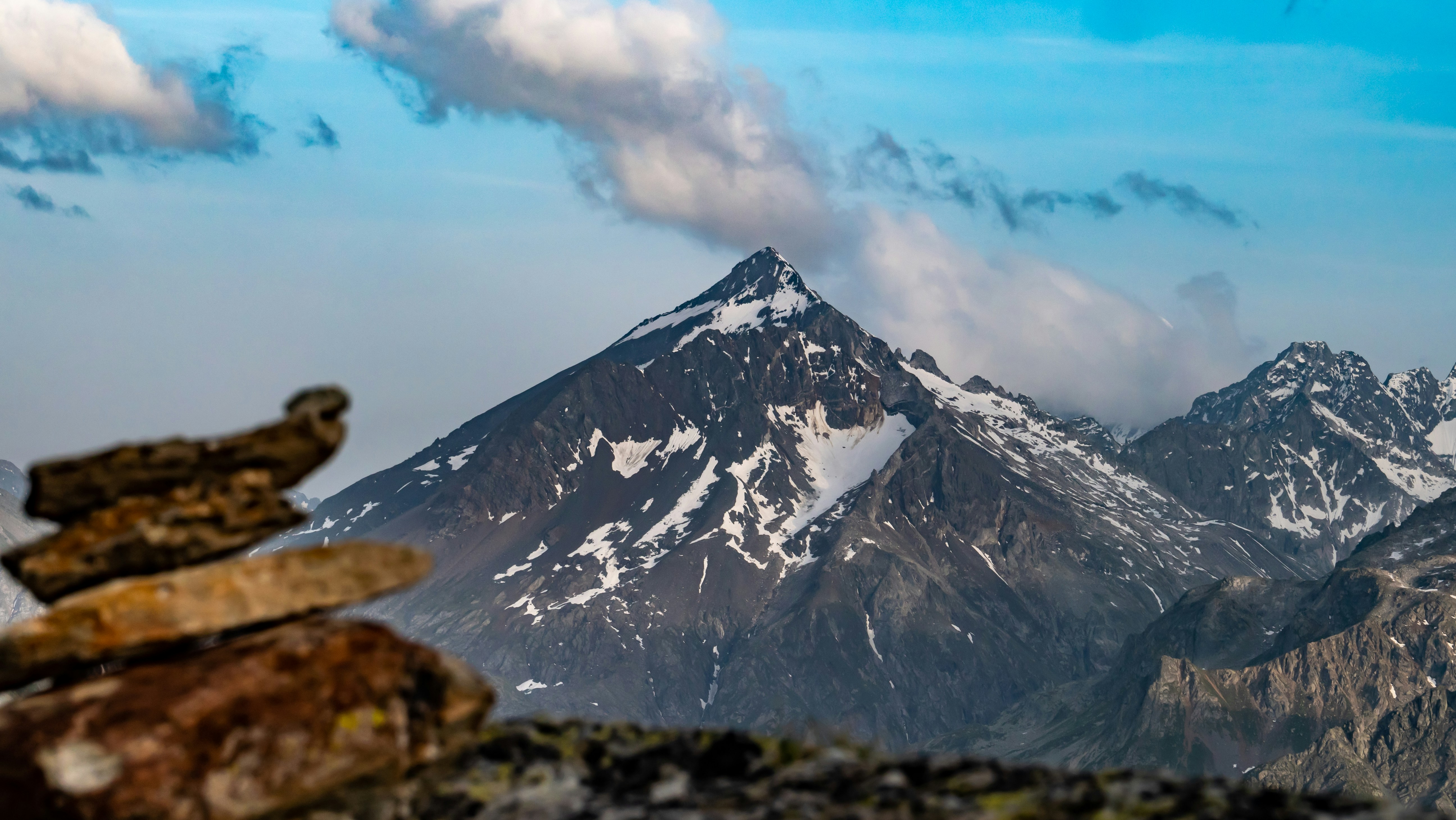 Peakwatch: Snow-Capped Summit Reigns Over a Shale Foreground