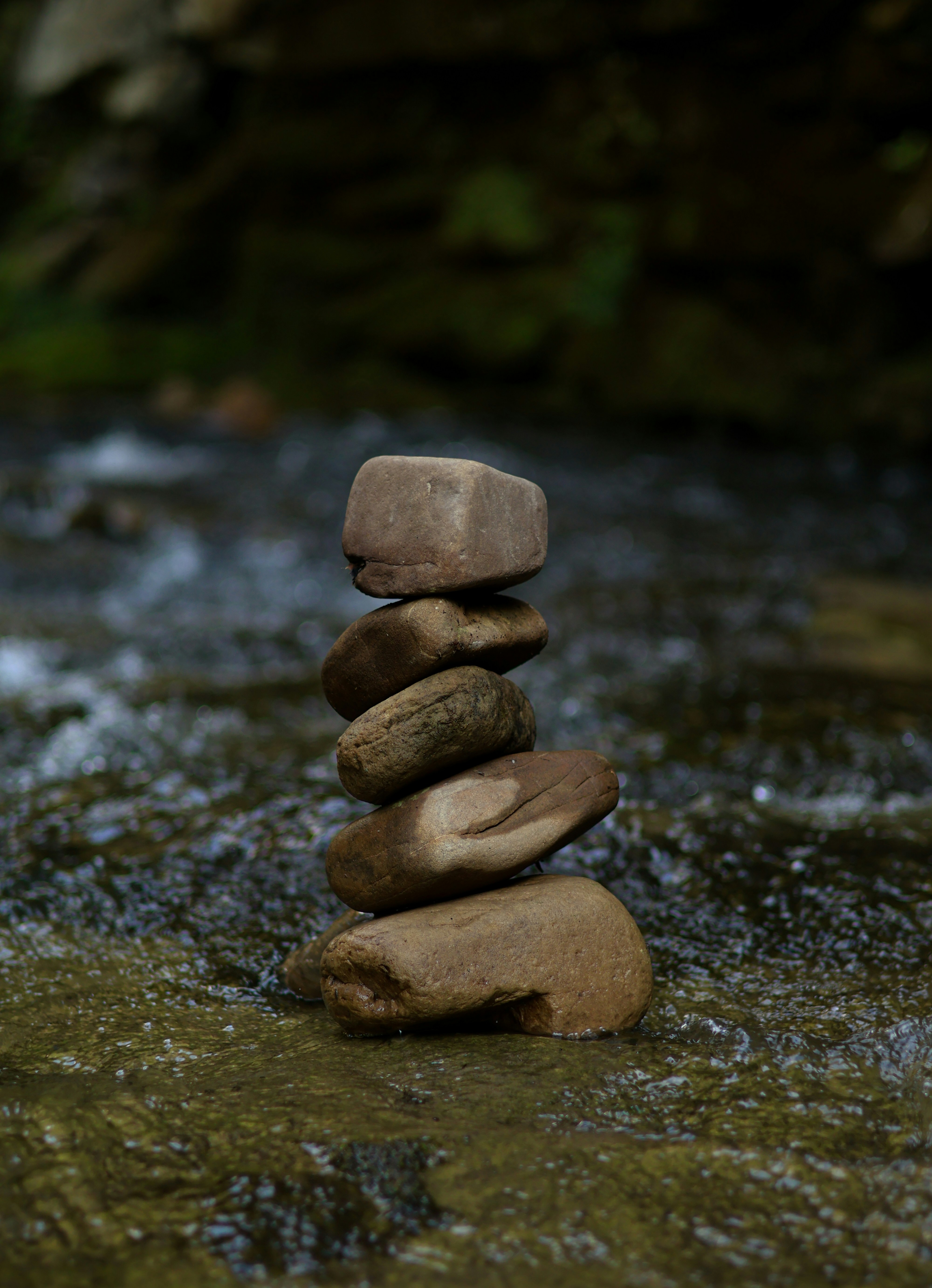 A stack of rocks sitting on top of a river photo – Free Ukraine Image ...