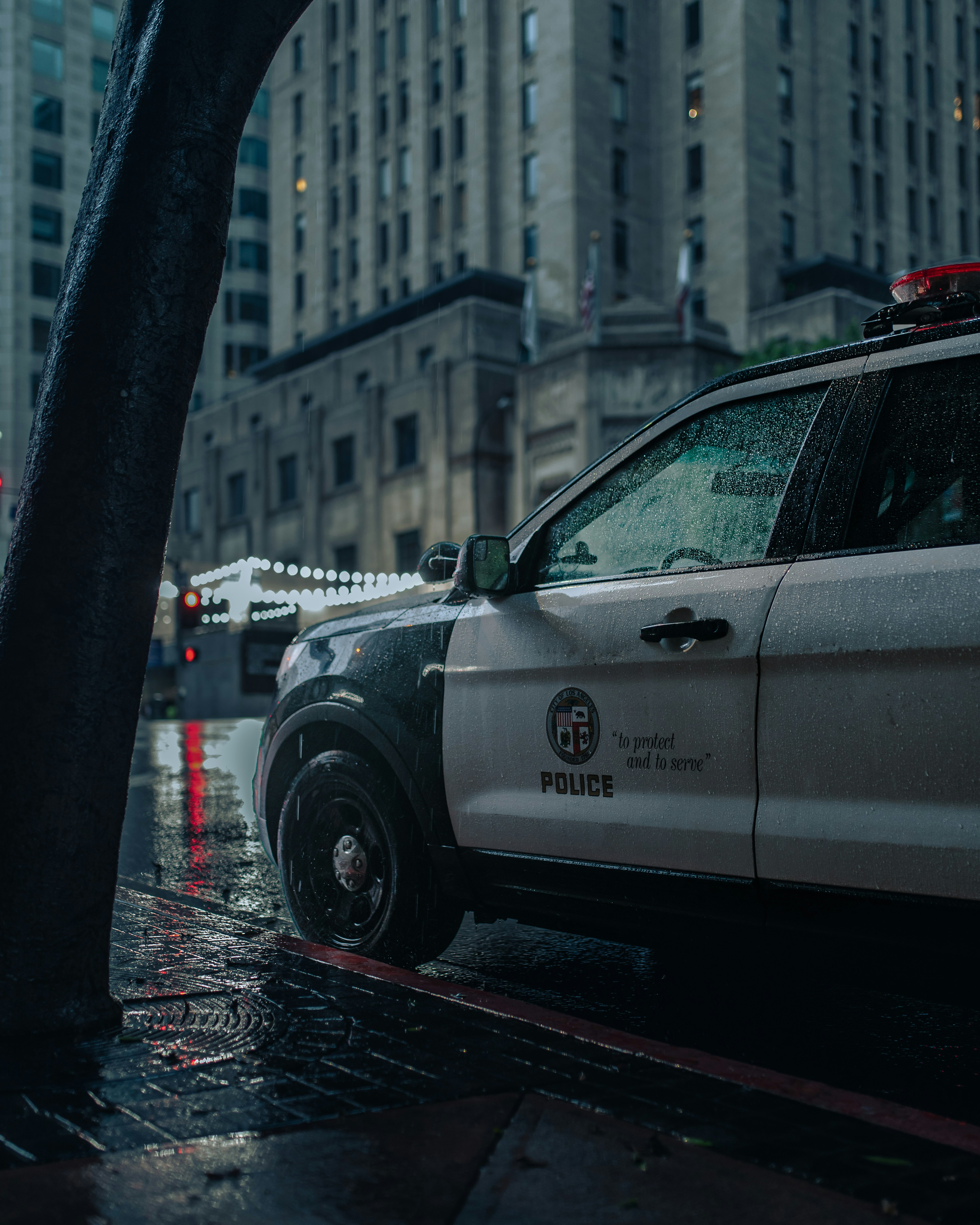 A police car parked on the side of the road photo – Free Street ...