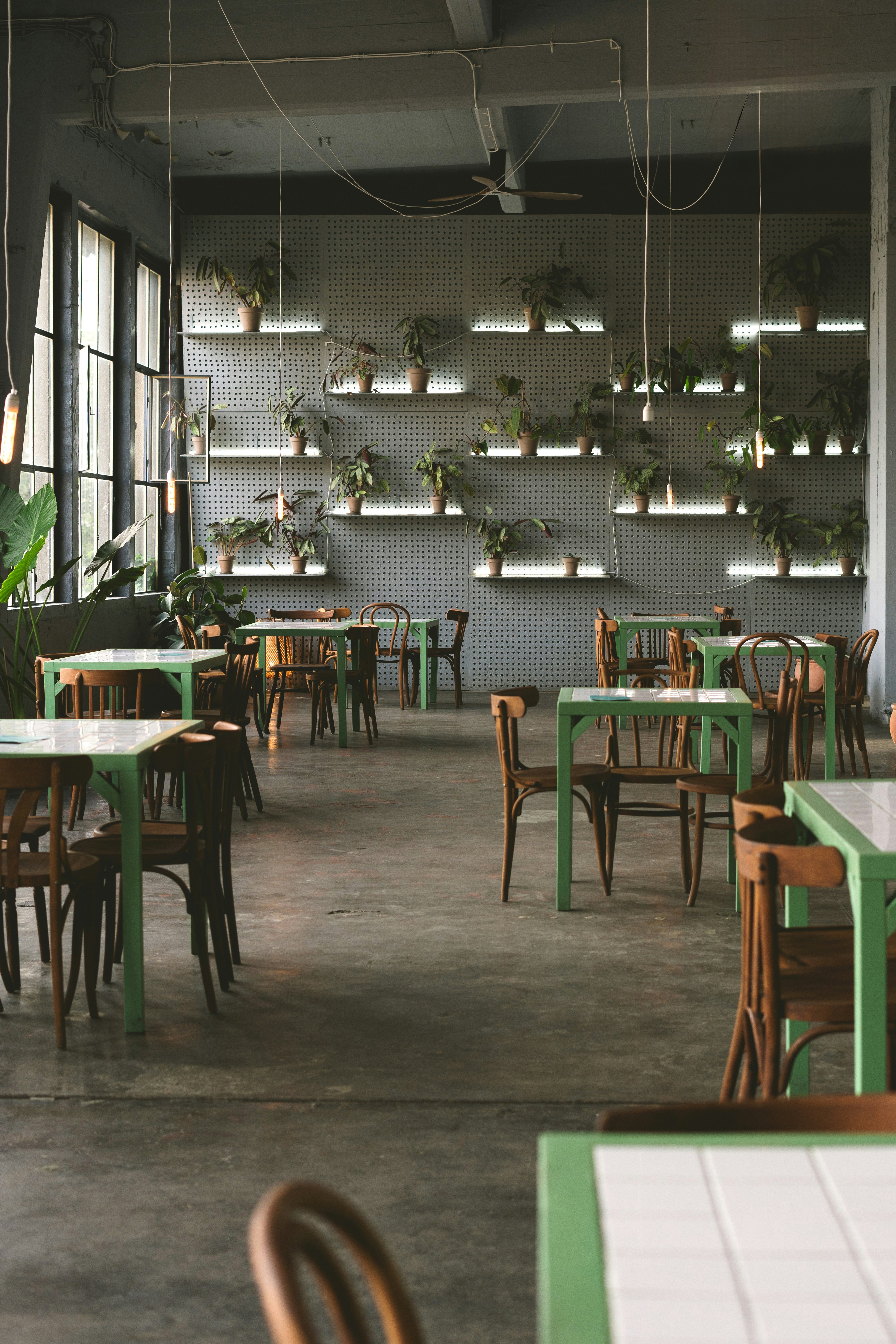 An empty restaurant with green tables and chairs photo – Free Interior ...