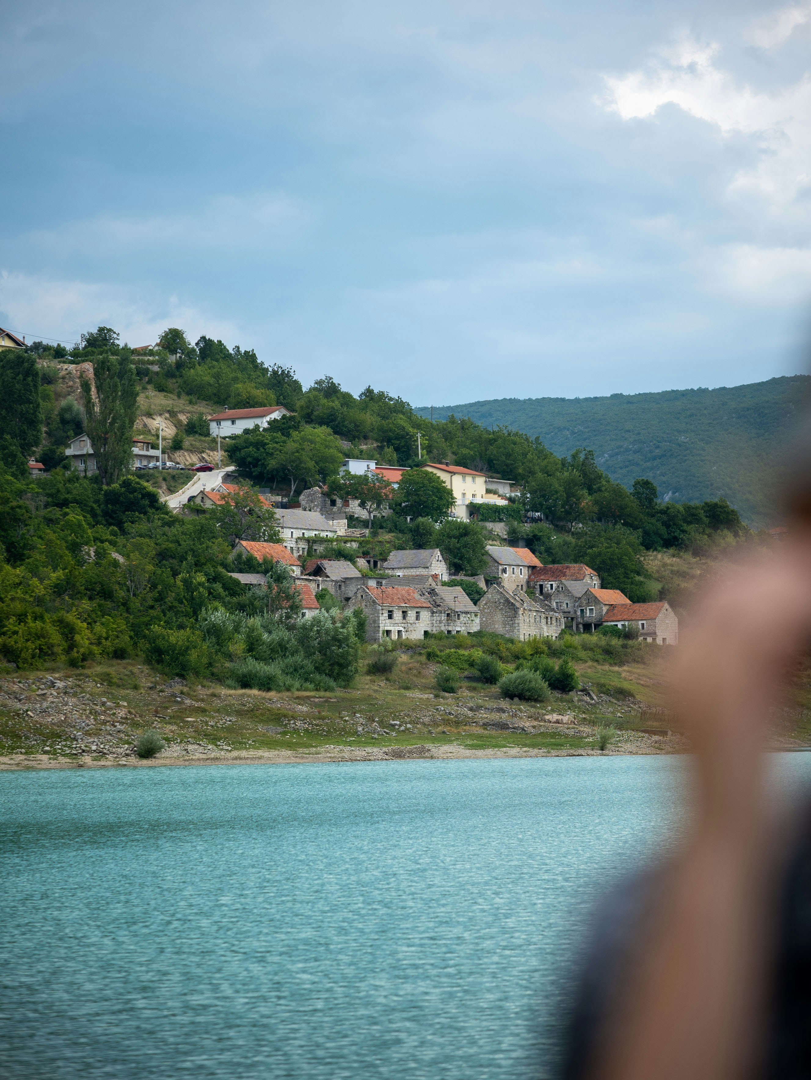 Village on the Shoreline: Quiet Dwellings Nestled by Turquoise Waters
