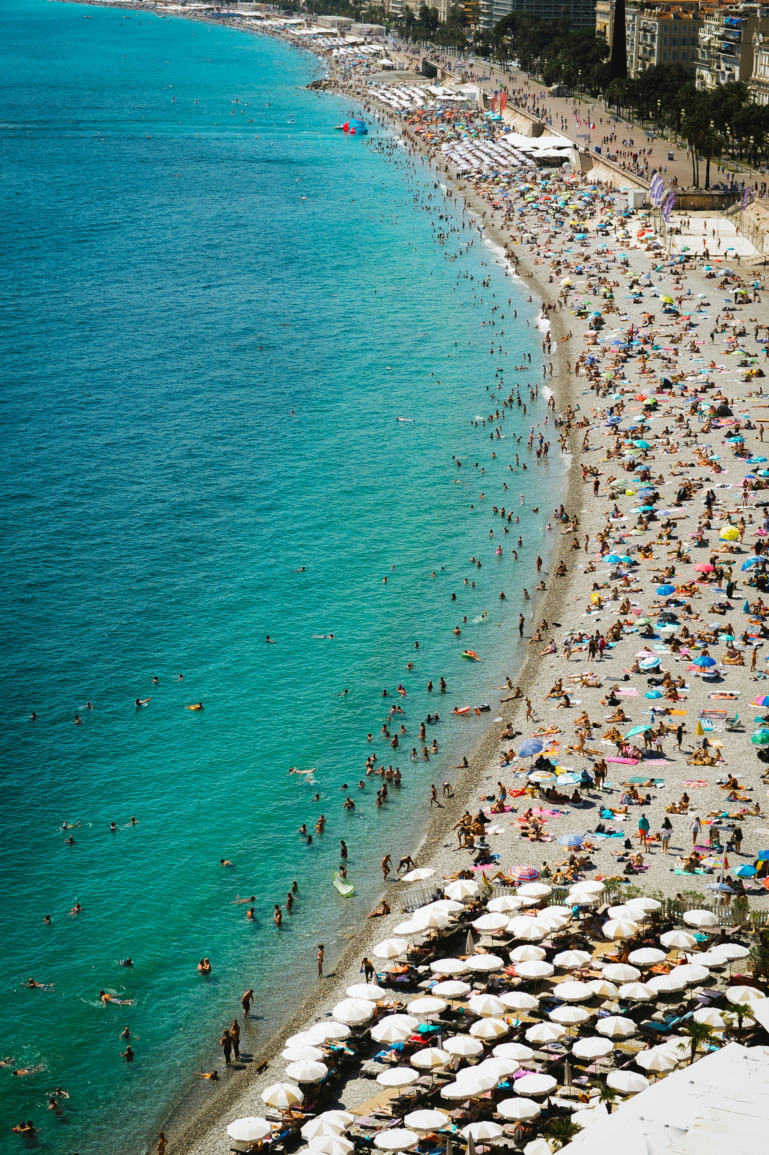 A crowded beach filled with people and umbrellas photo – Free Water ...