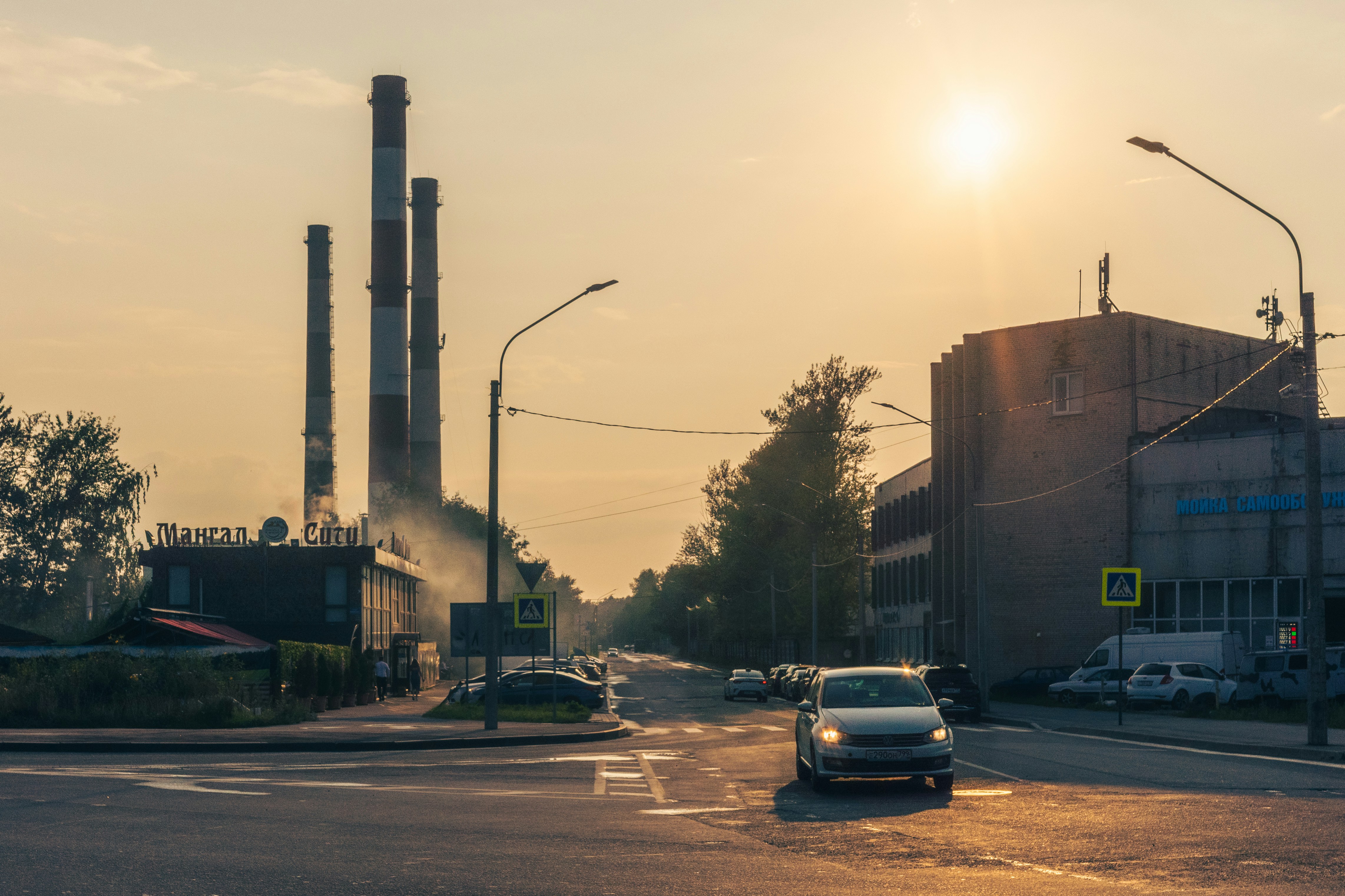 Golden Hour on the Industrial Boulevard: Chimneys, Cars, and Quiet Traffic
