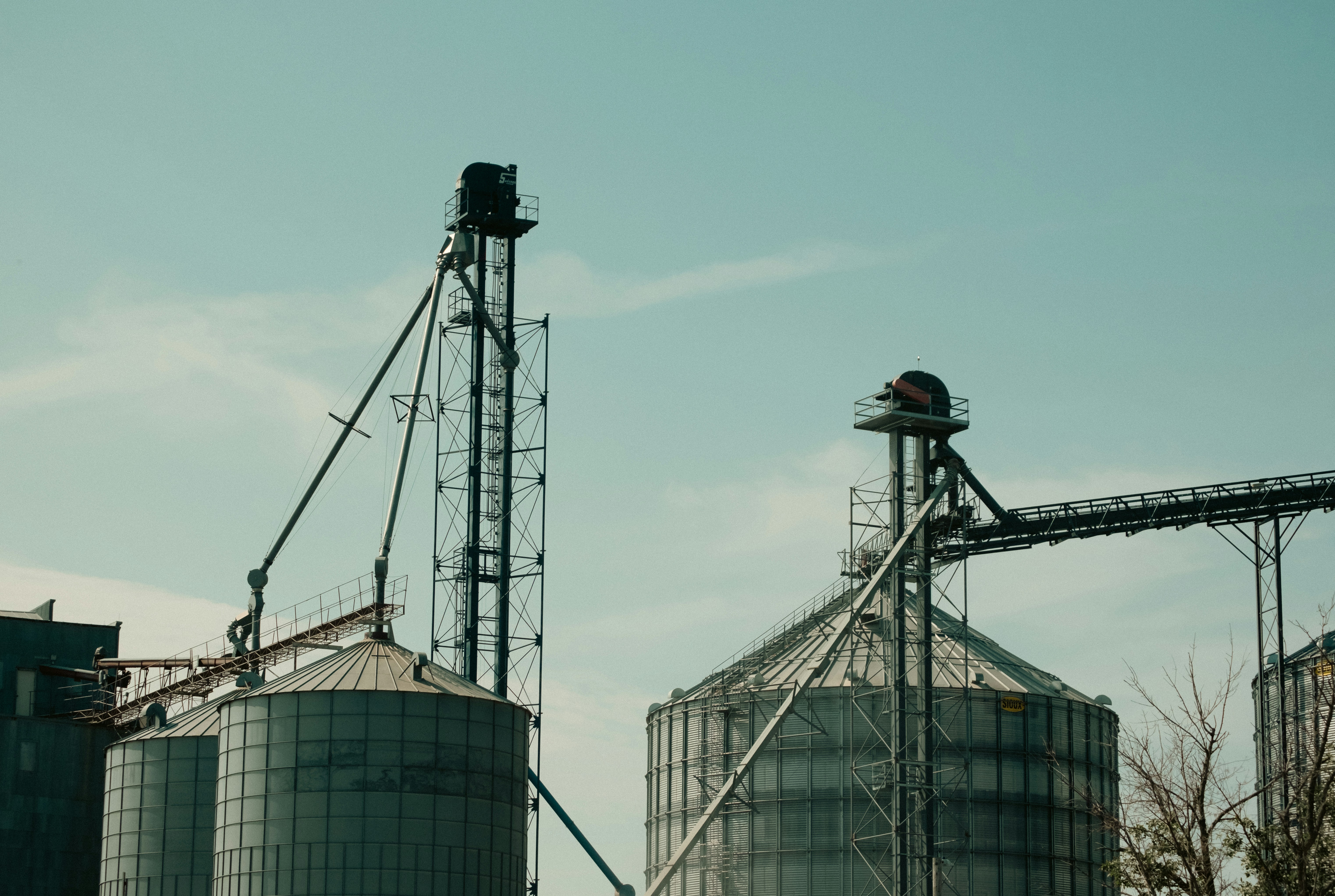 A couple of large silos sitting next to each other photo – Free ...
