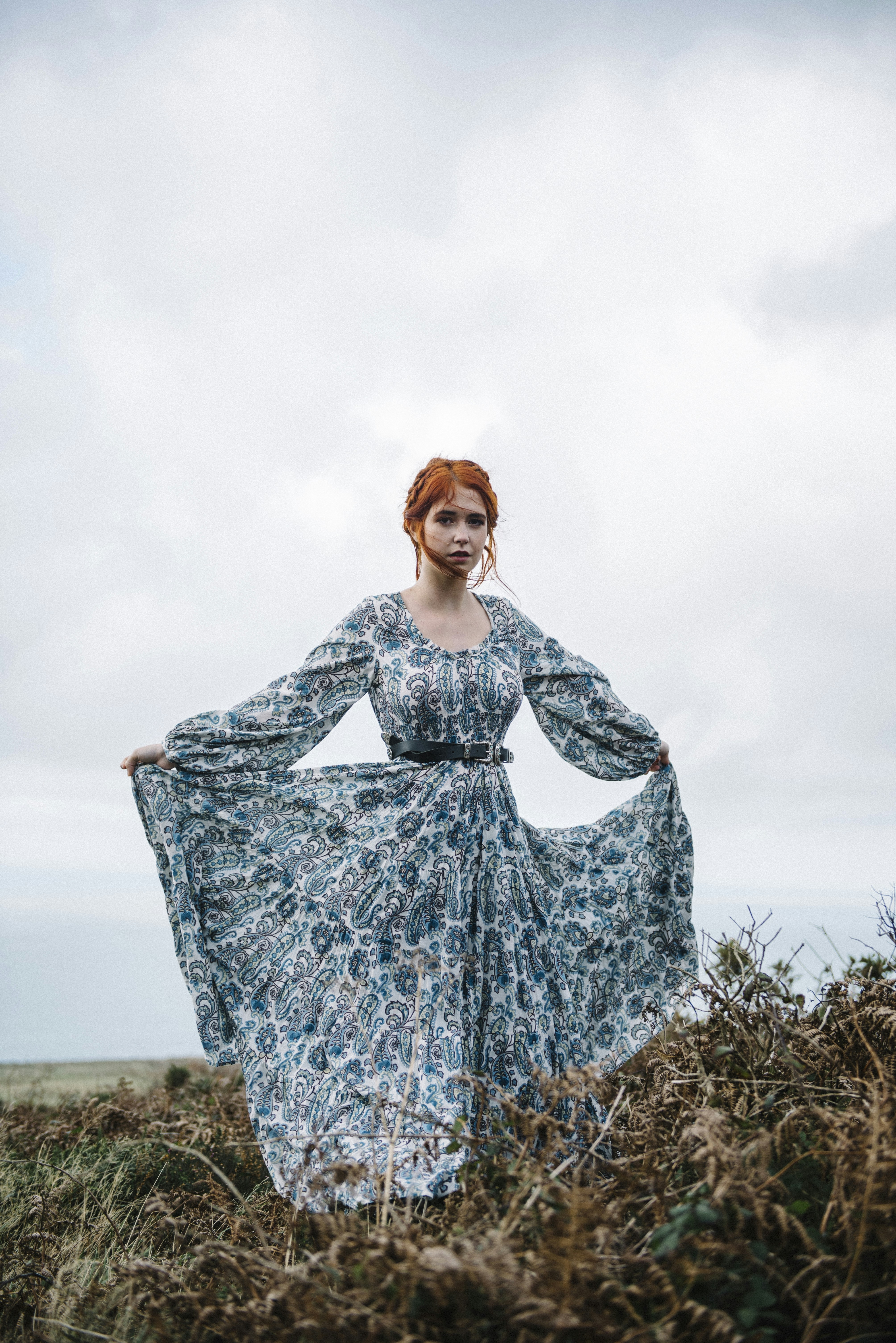 Red-Haired Portrait in a Wind-Swept Paisley Dress on the Coastal Dune
