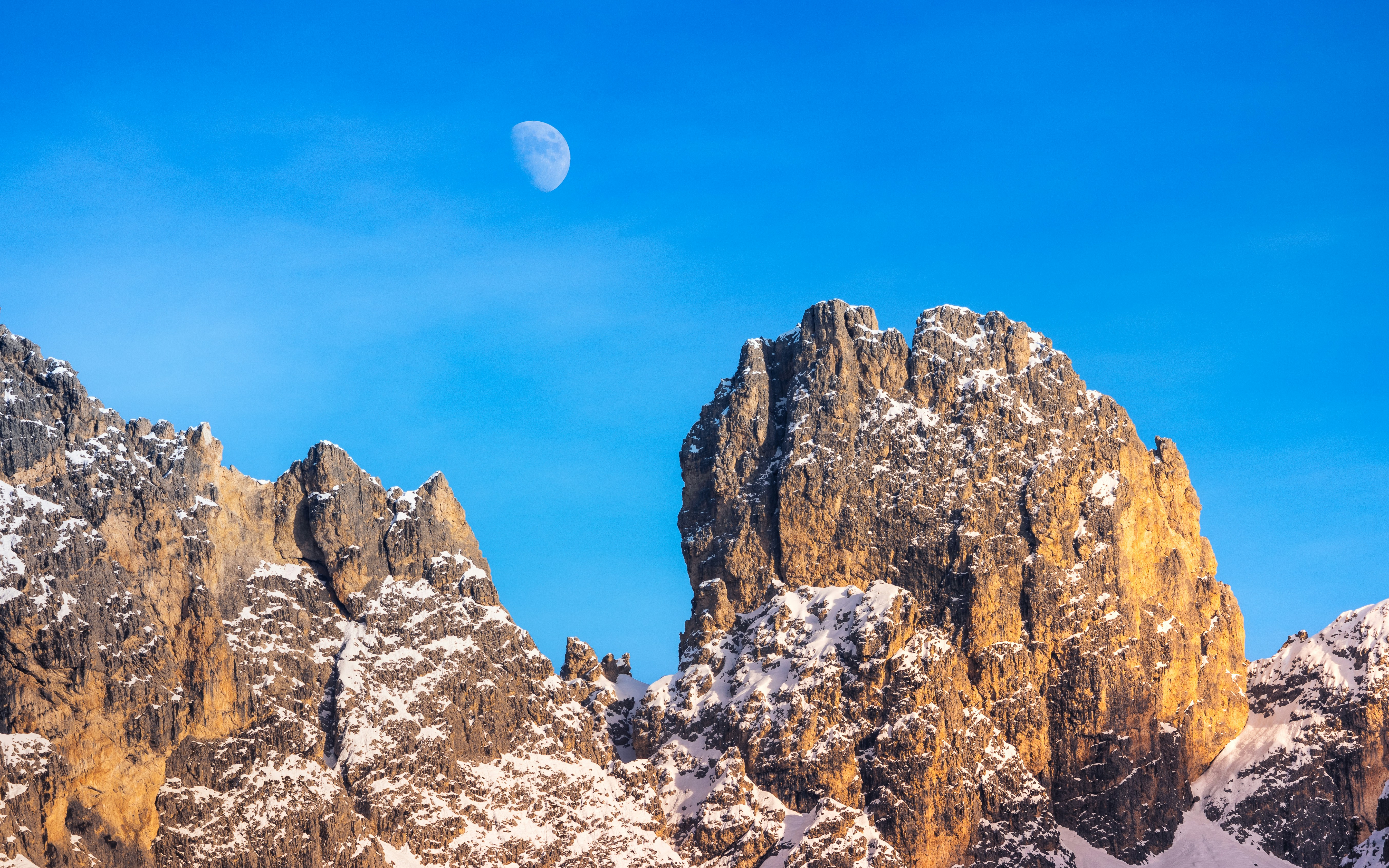 A full moon is seen above a snowy mountain range photo – Free Moon ...