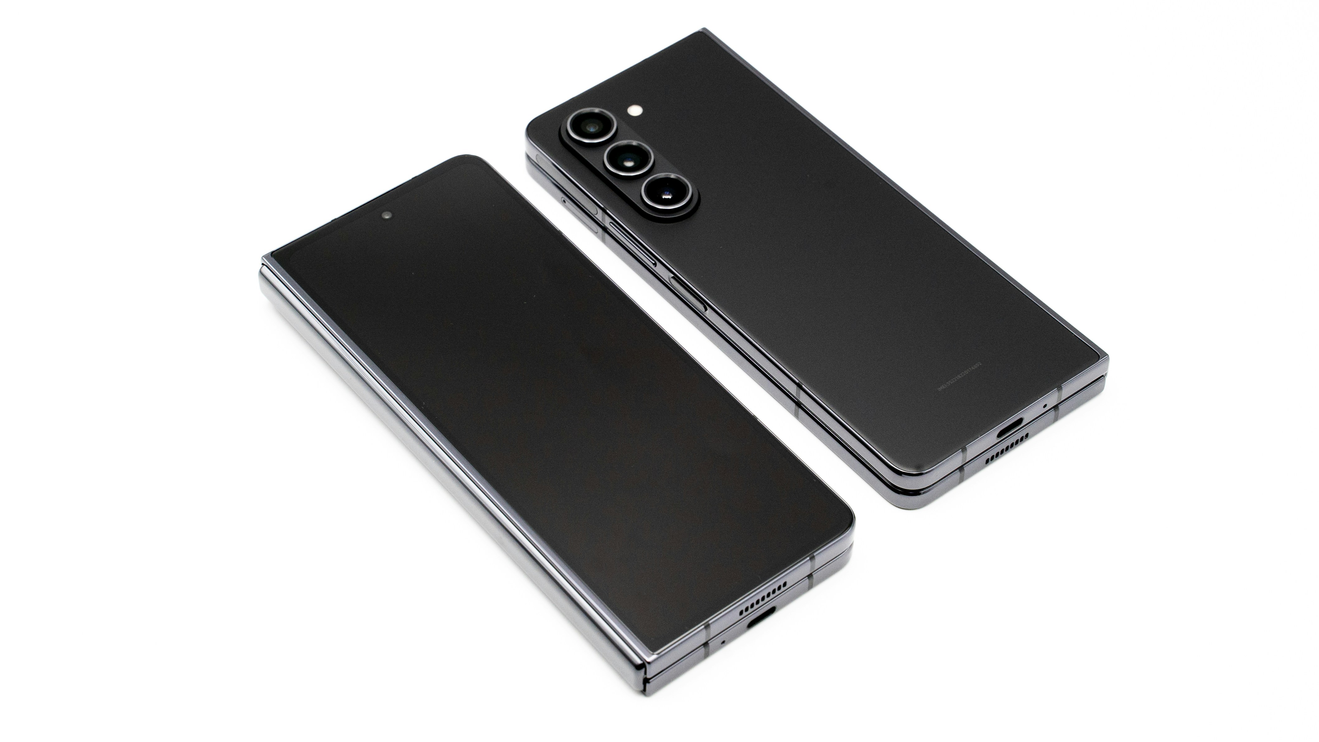 Two black phones side by side on a white surface photo – Free ...