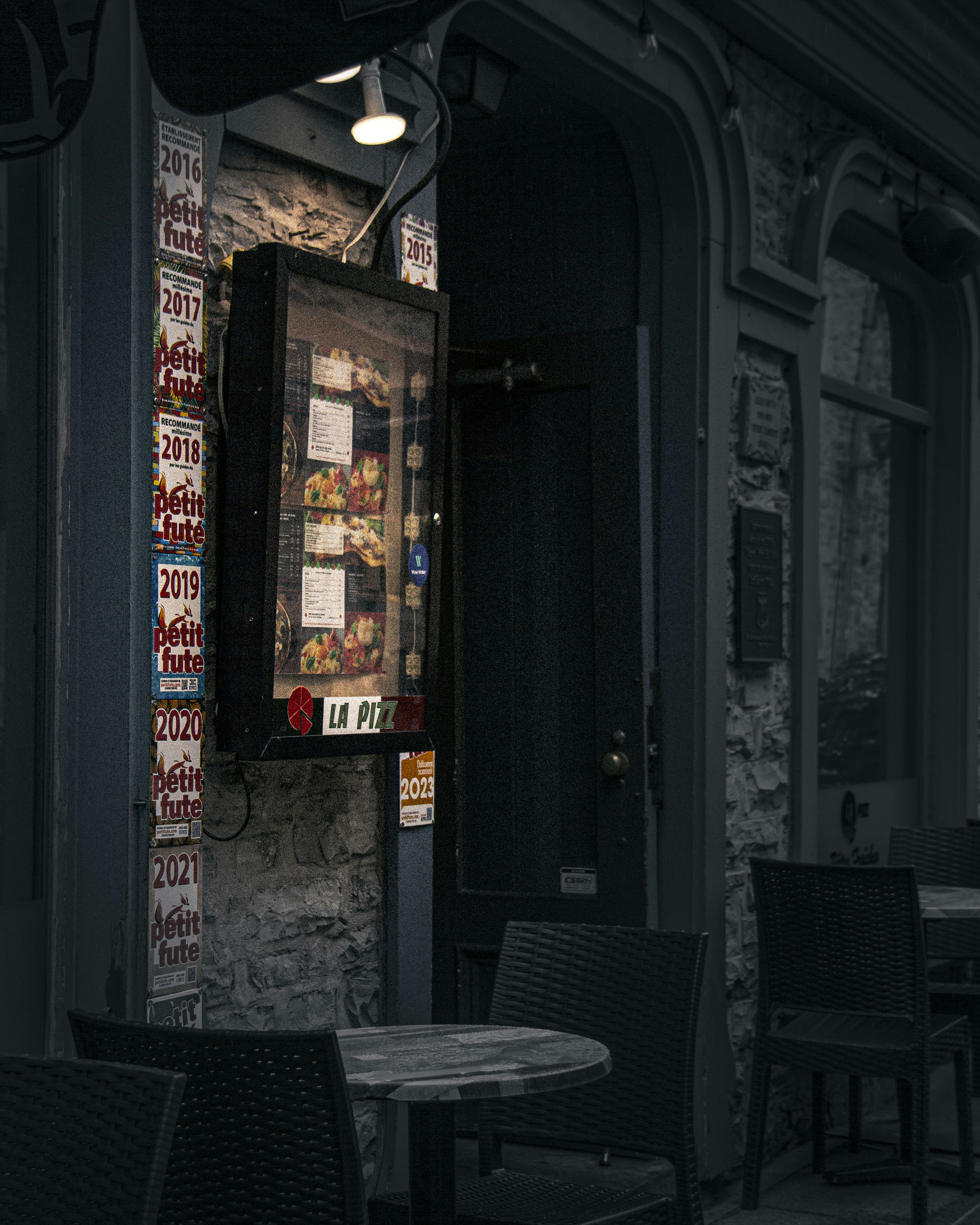 Night Display Case at a Stone-Walled Bistro: Quiet Light on a Doorway Menu