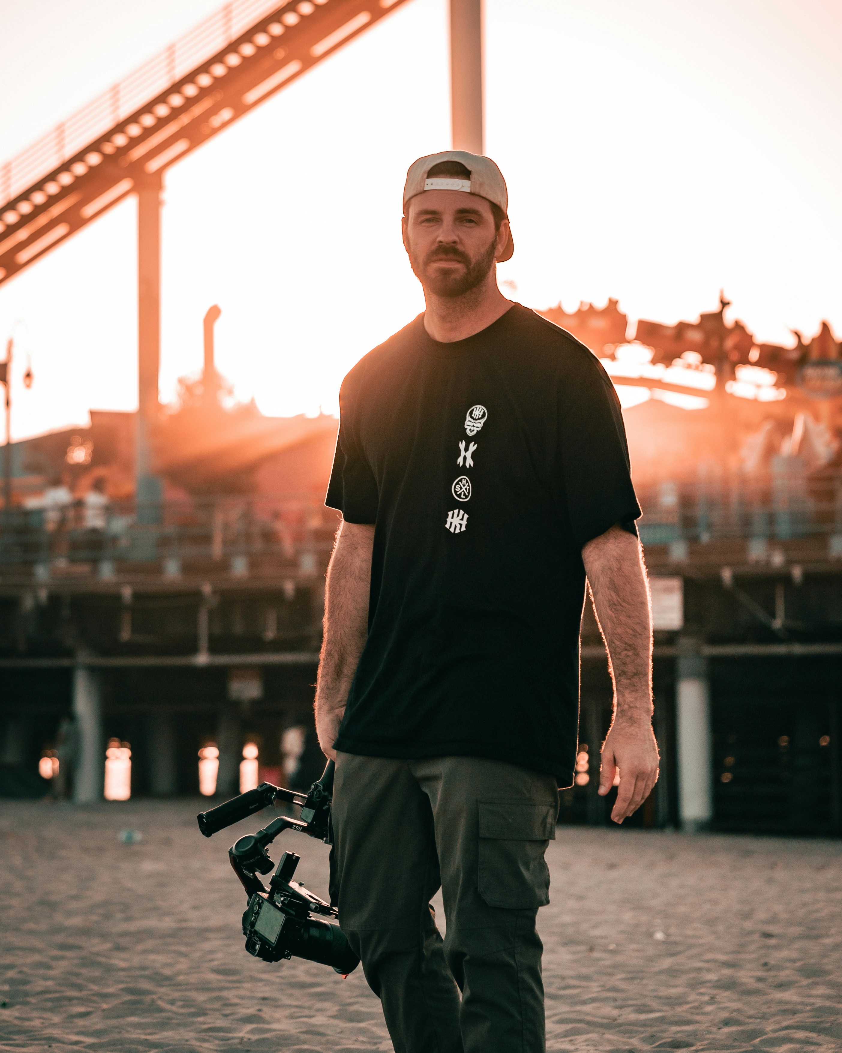Sunset Backlight on a Gear-Wielding Filmmaker at the Pier