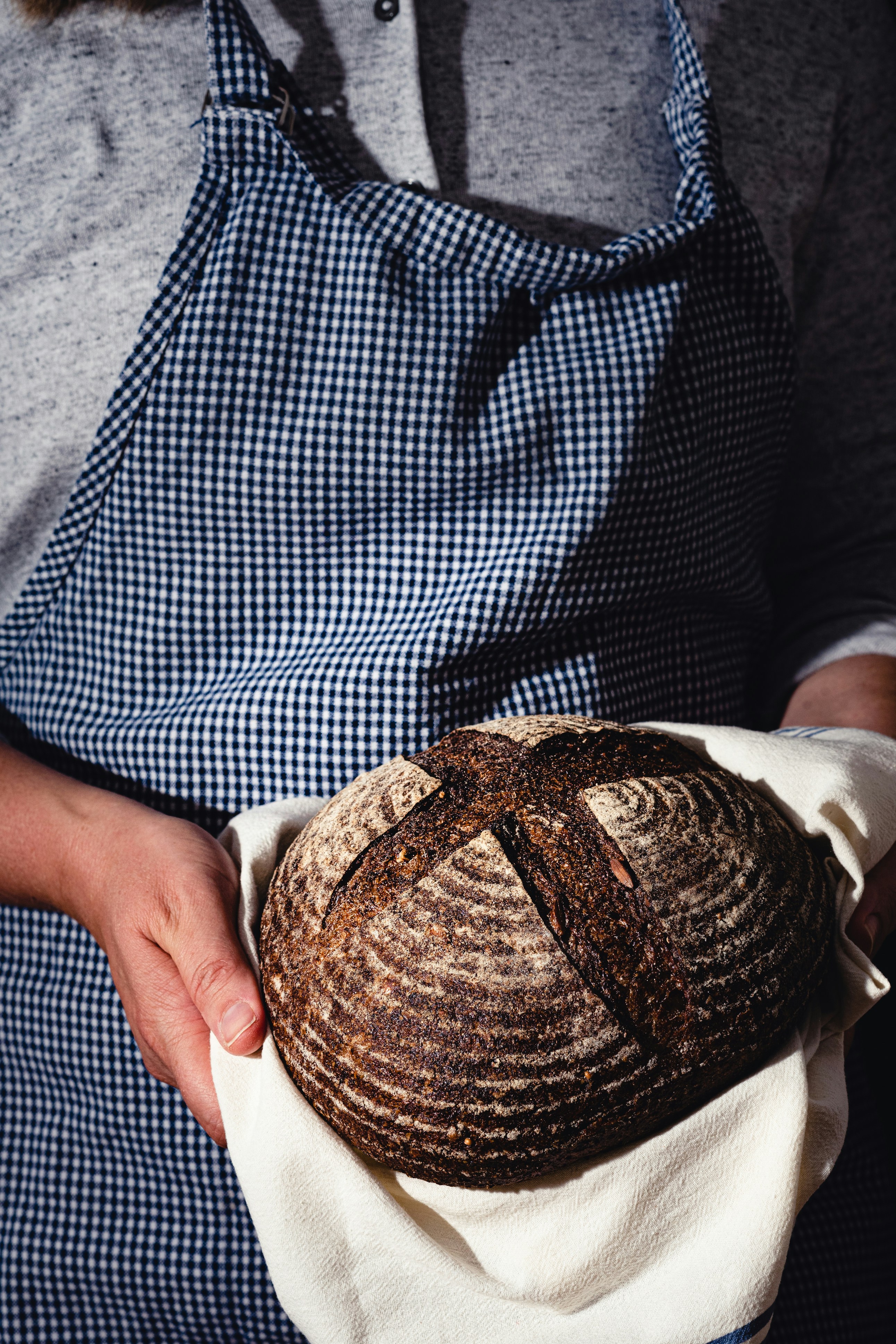A person holding a loaf of bread in their hands photo – Free Female ...