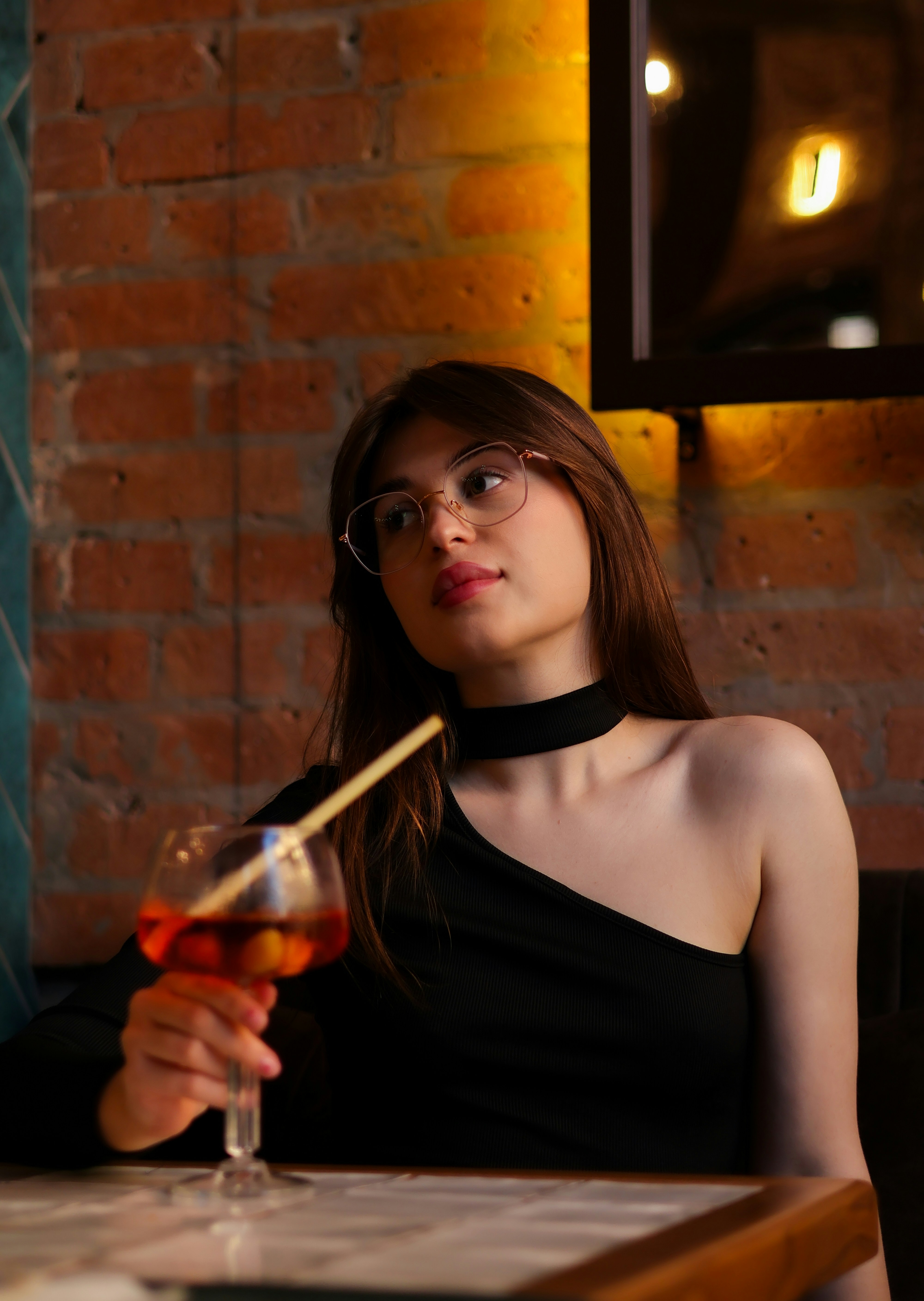 Glassy gaze in a neon-lit lounge