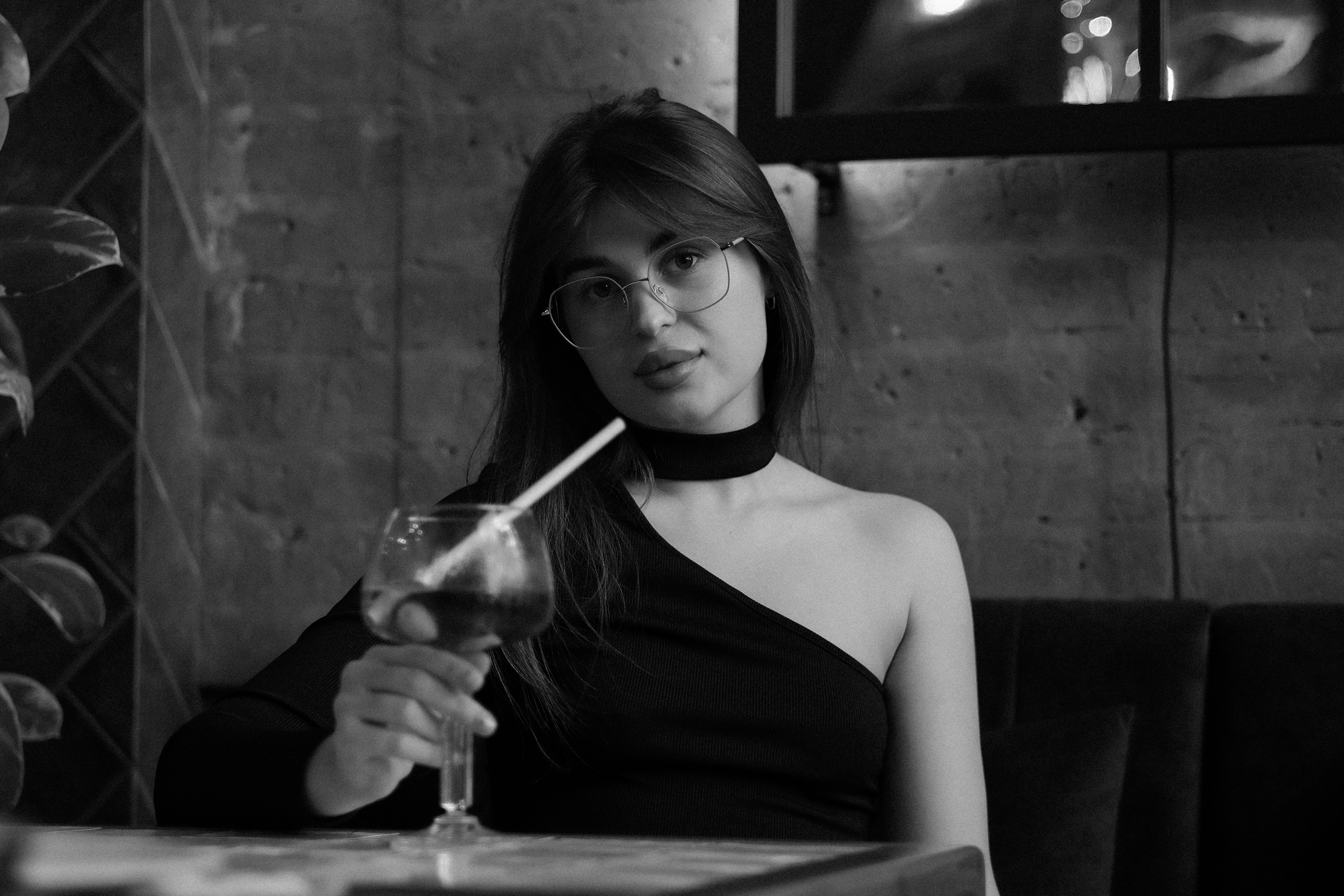 Noir Pause: A One-Shoulder Portrait in a Quiet Café