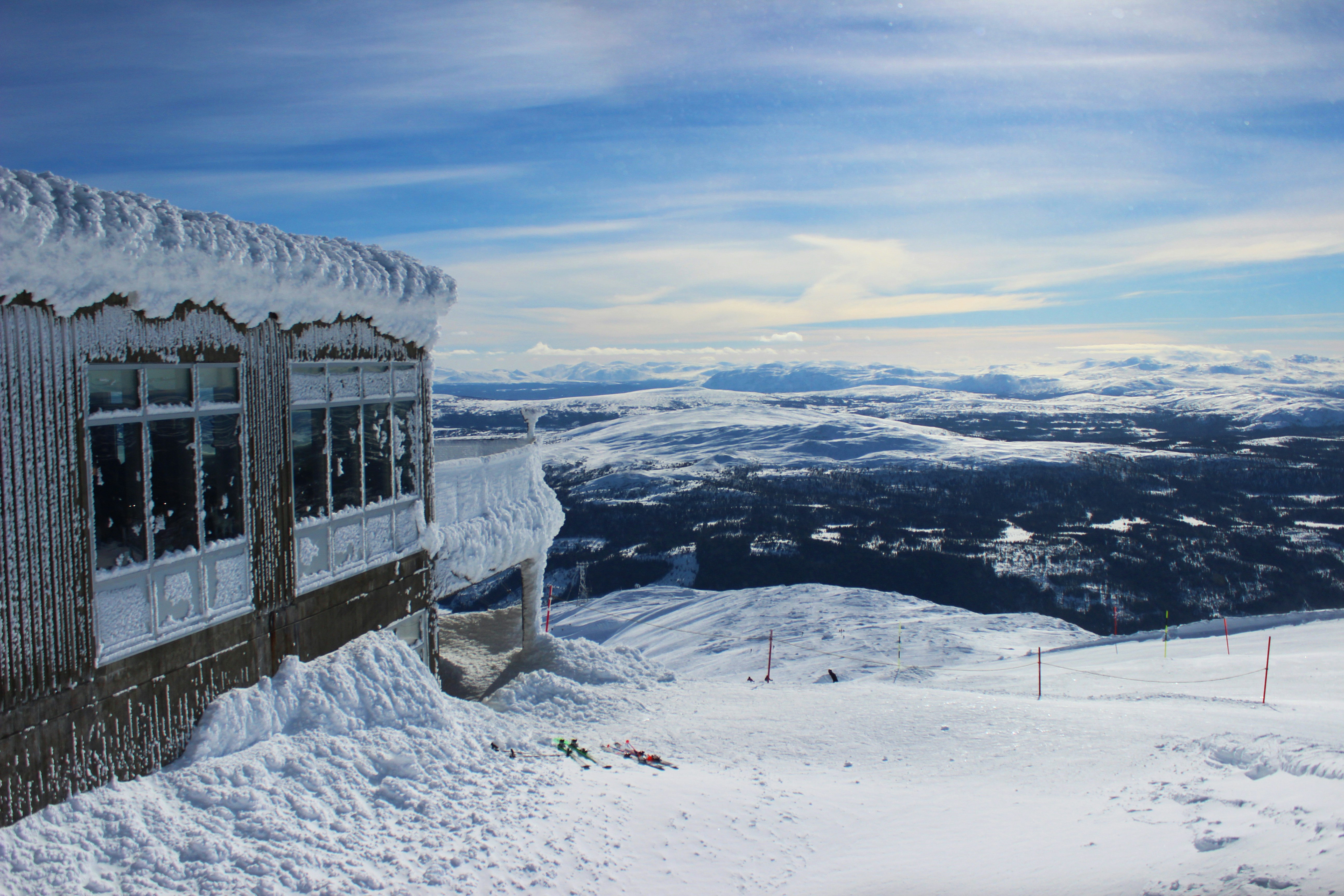 A view of a snowy mountain with a building in the foreground photo ...