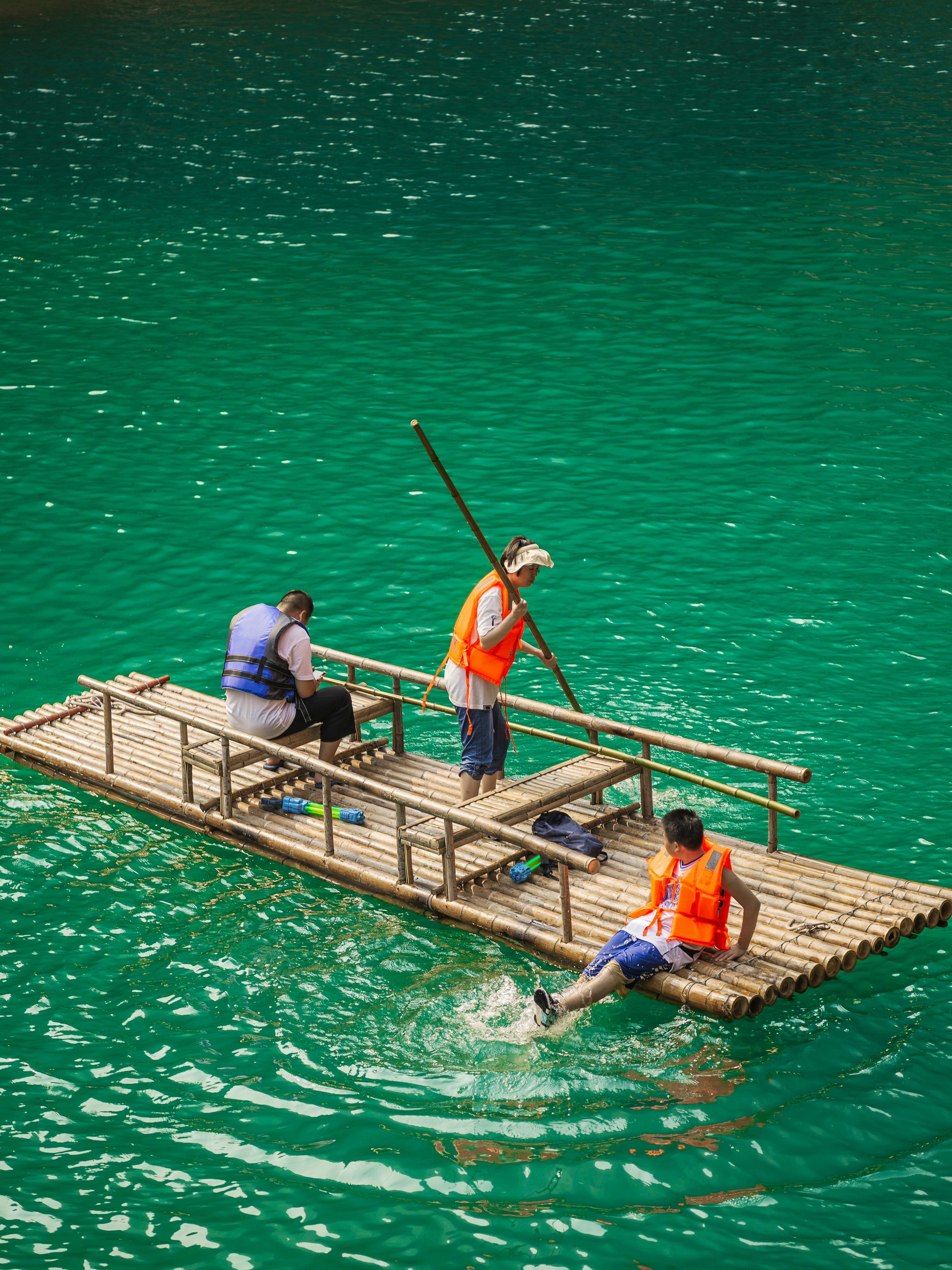 A group of people on a raft in the water photo – Free Waterfront Image ...