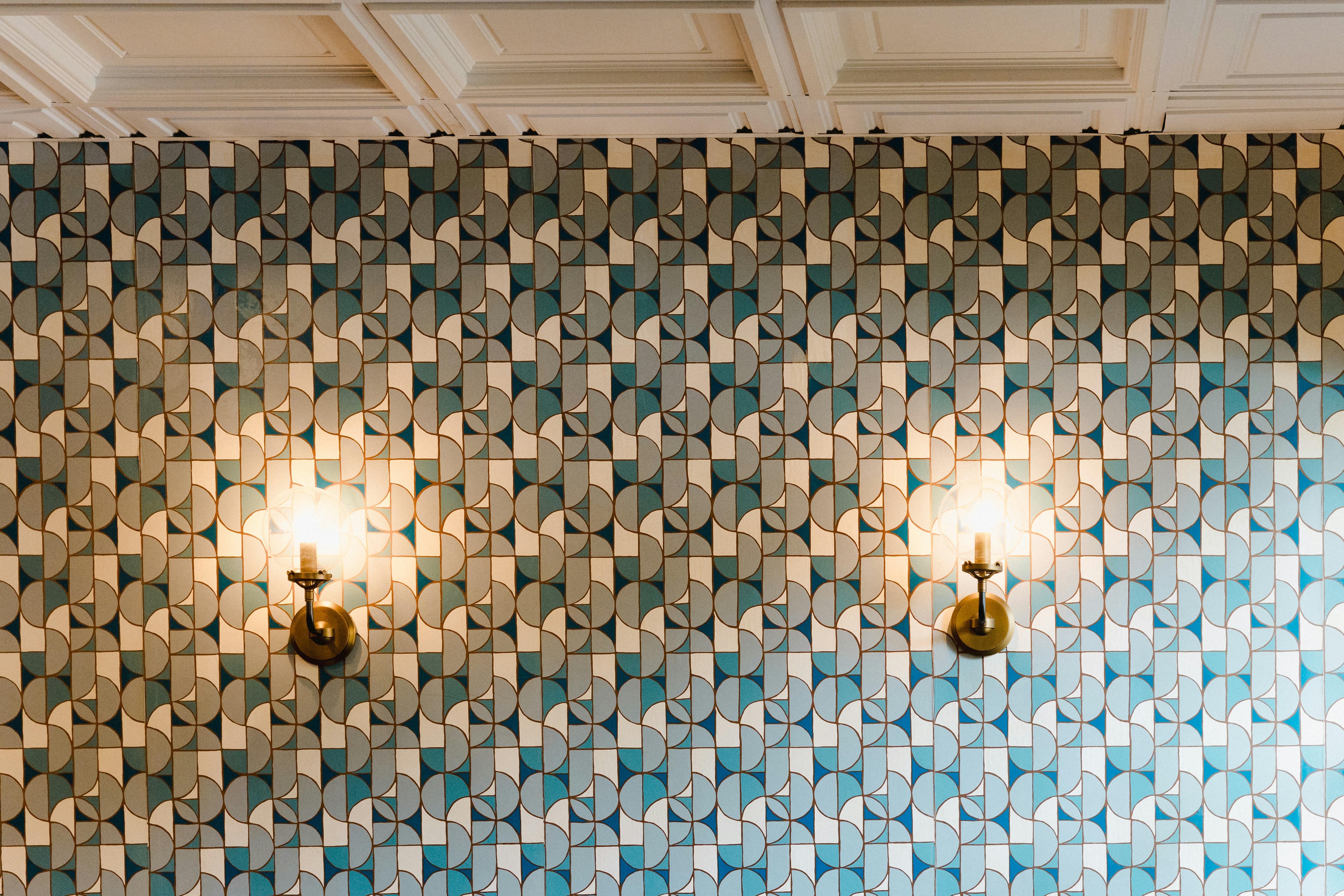 A tiled wall with two lights on it photo – Free Indoors Image on Unsplash
