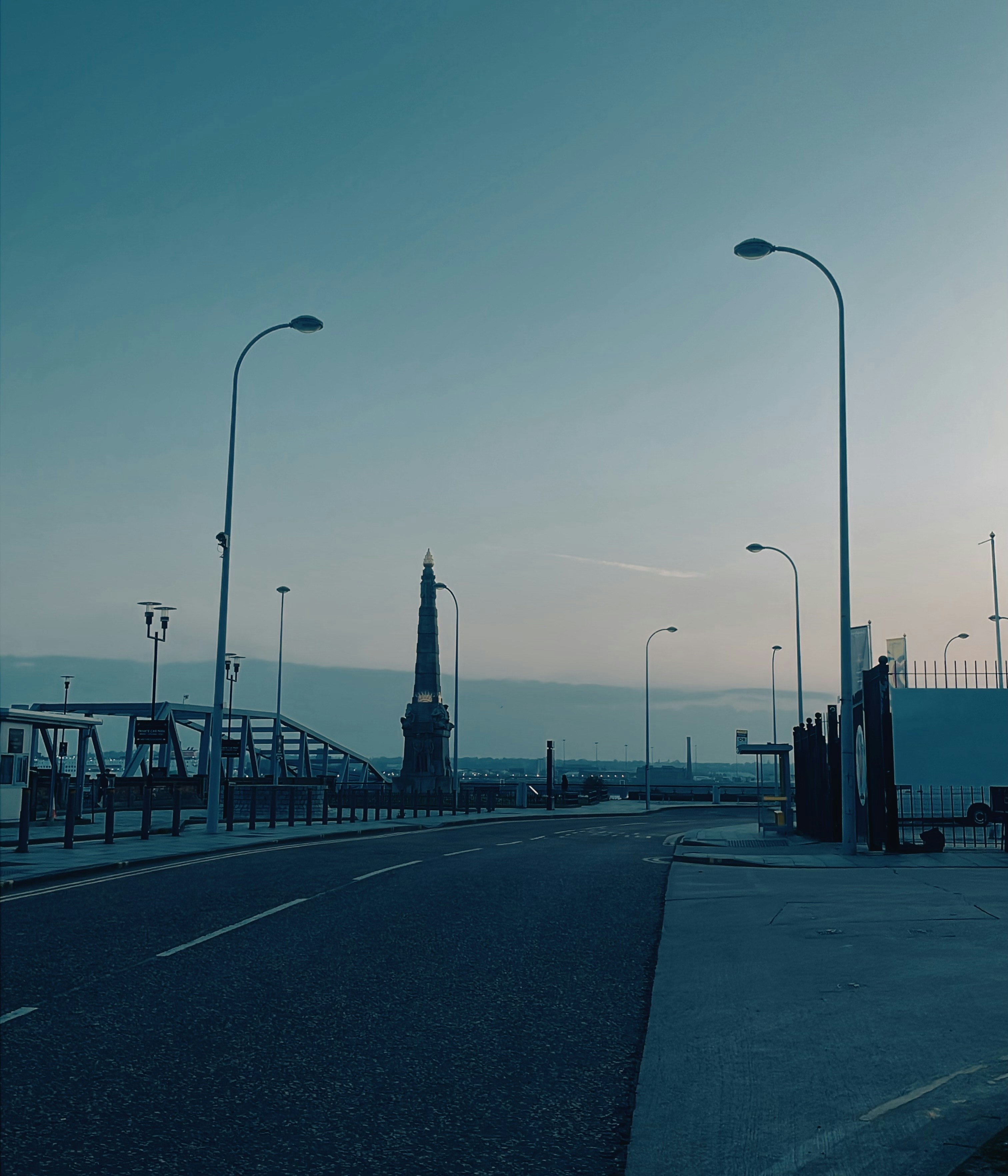 A city street with a clock tower in the distance photo – Free ...