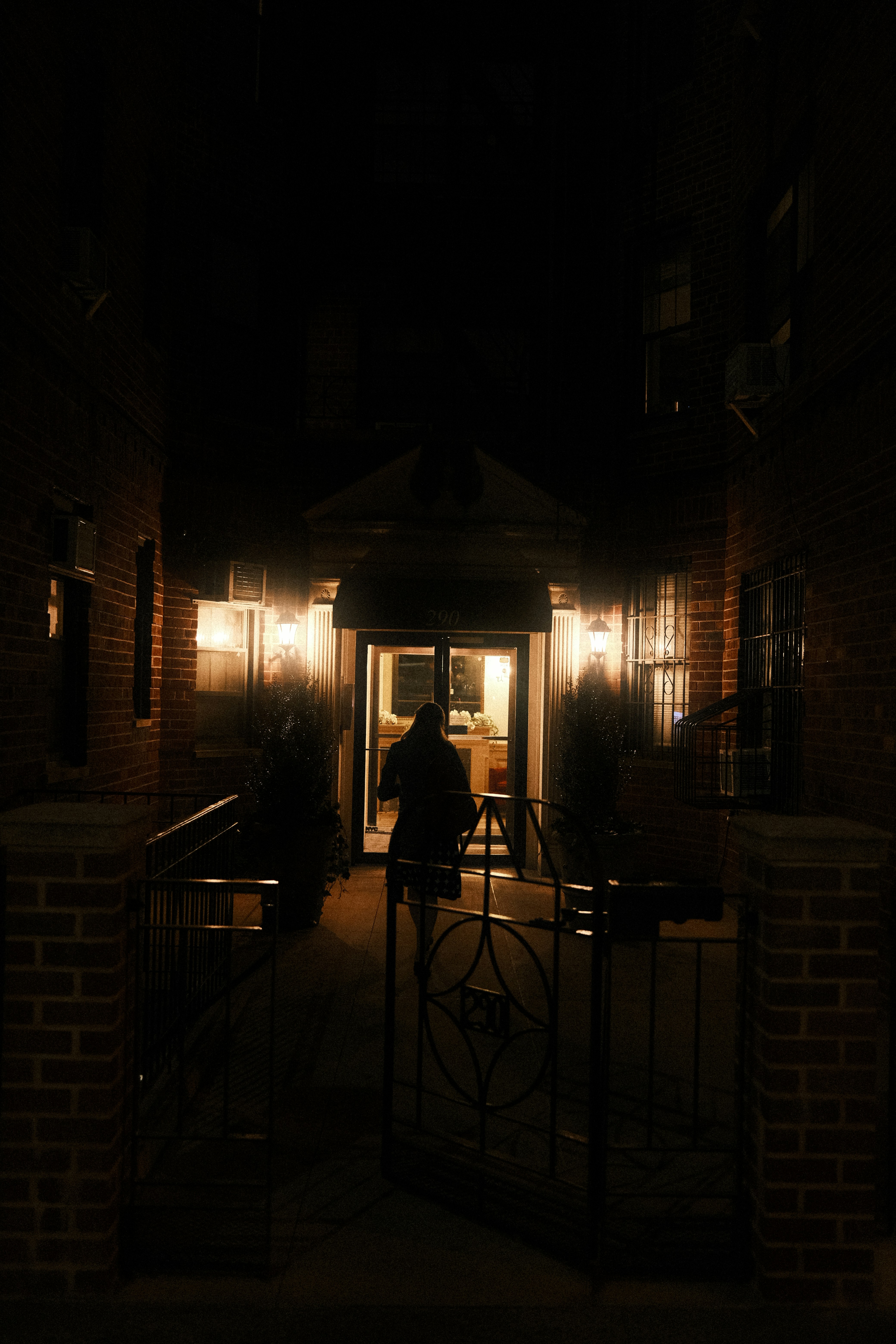 Doorway Quiet: A Nighttime Silhouette in Warm Light