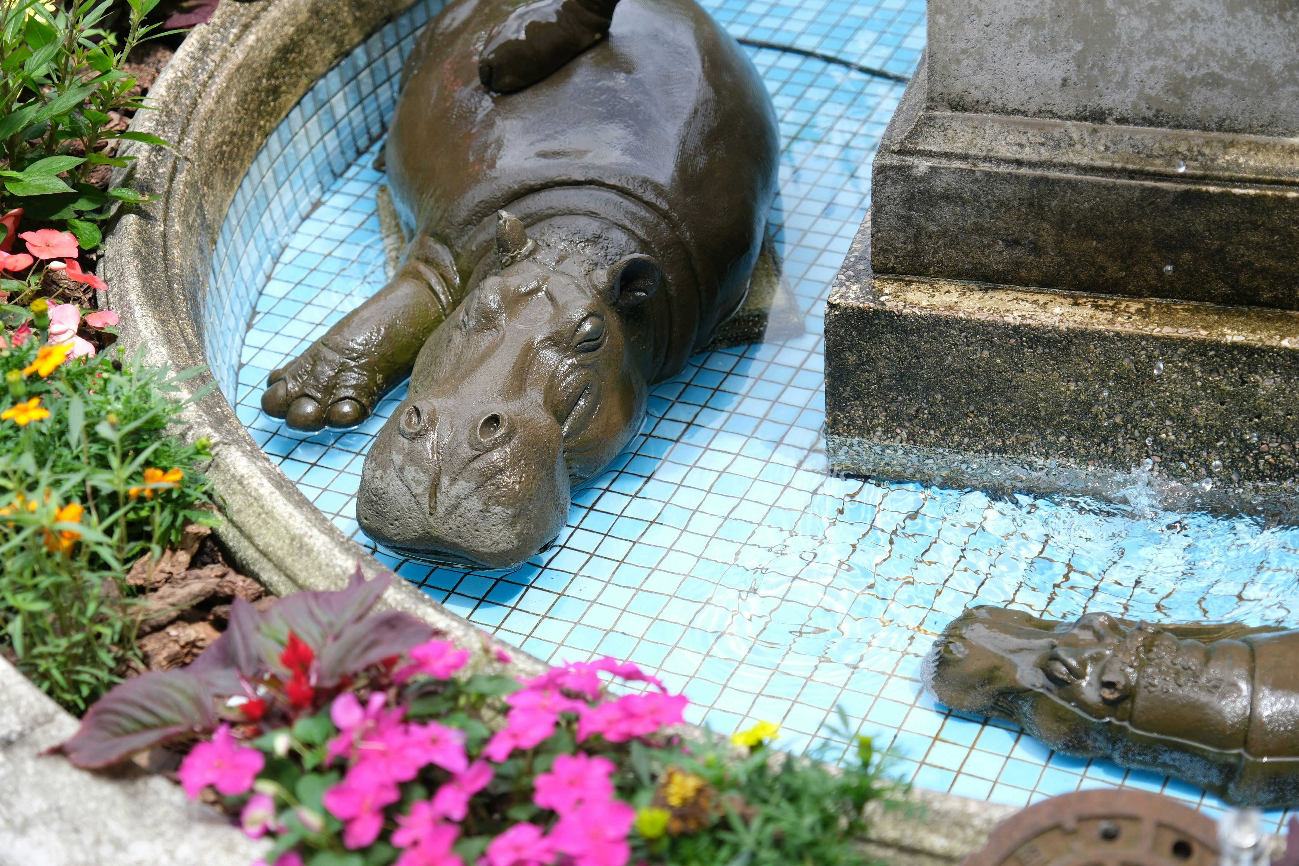 Blue Mosaic Hippo: A Quiet Moment in the Garden Fountain