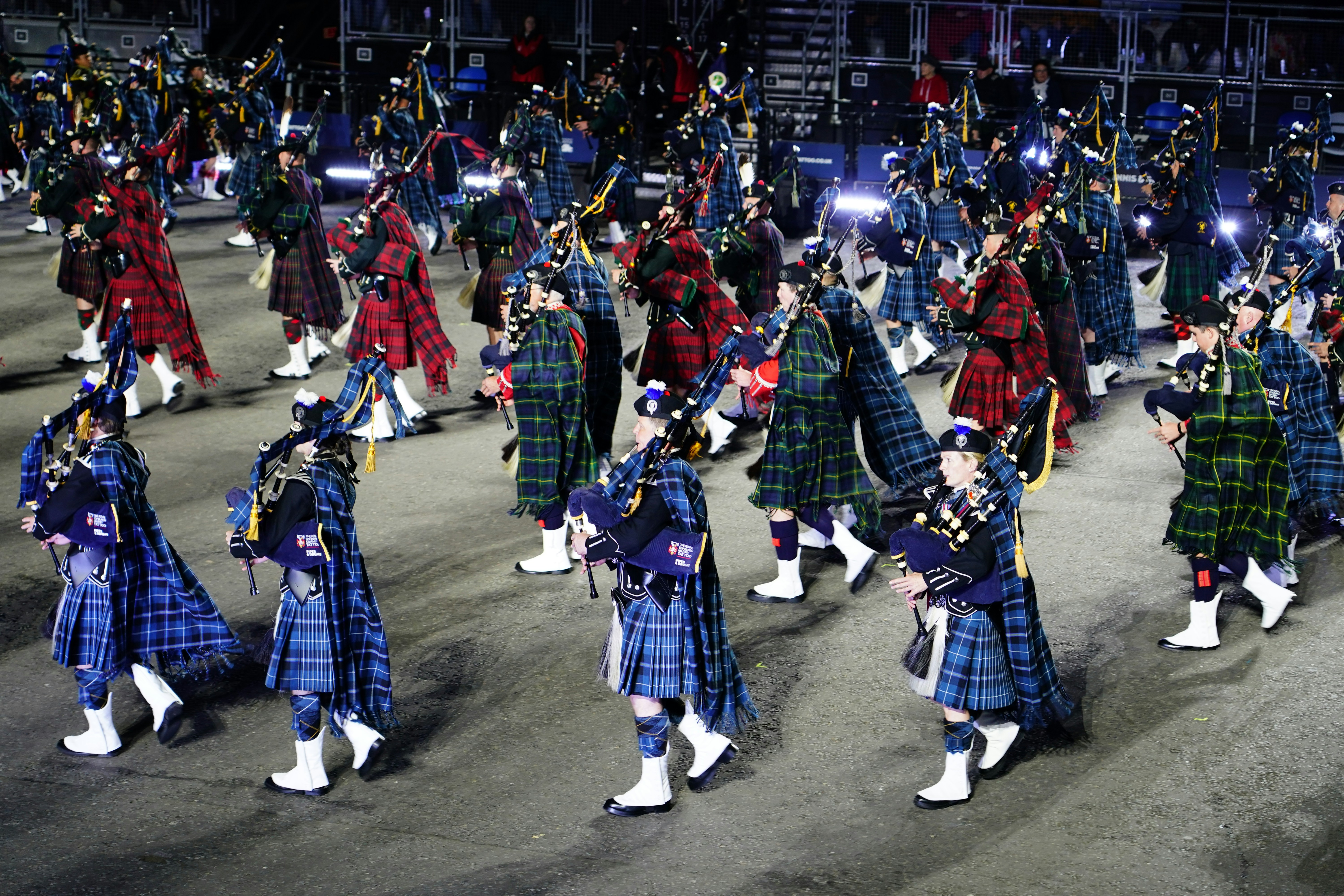 A group of men in kilts marching down a street photo – Free Person ...