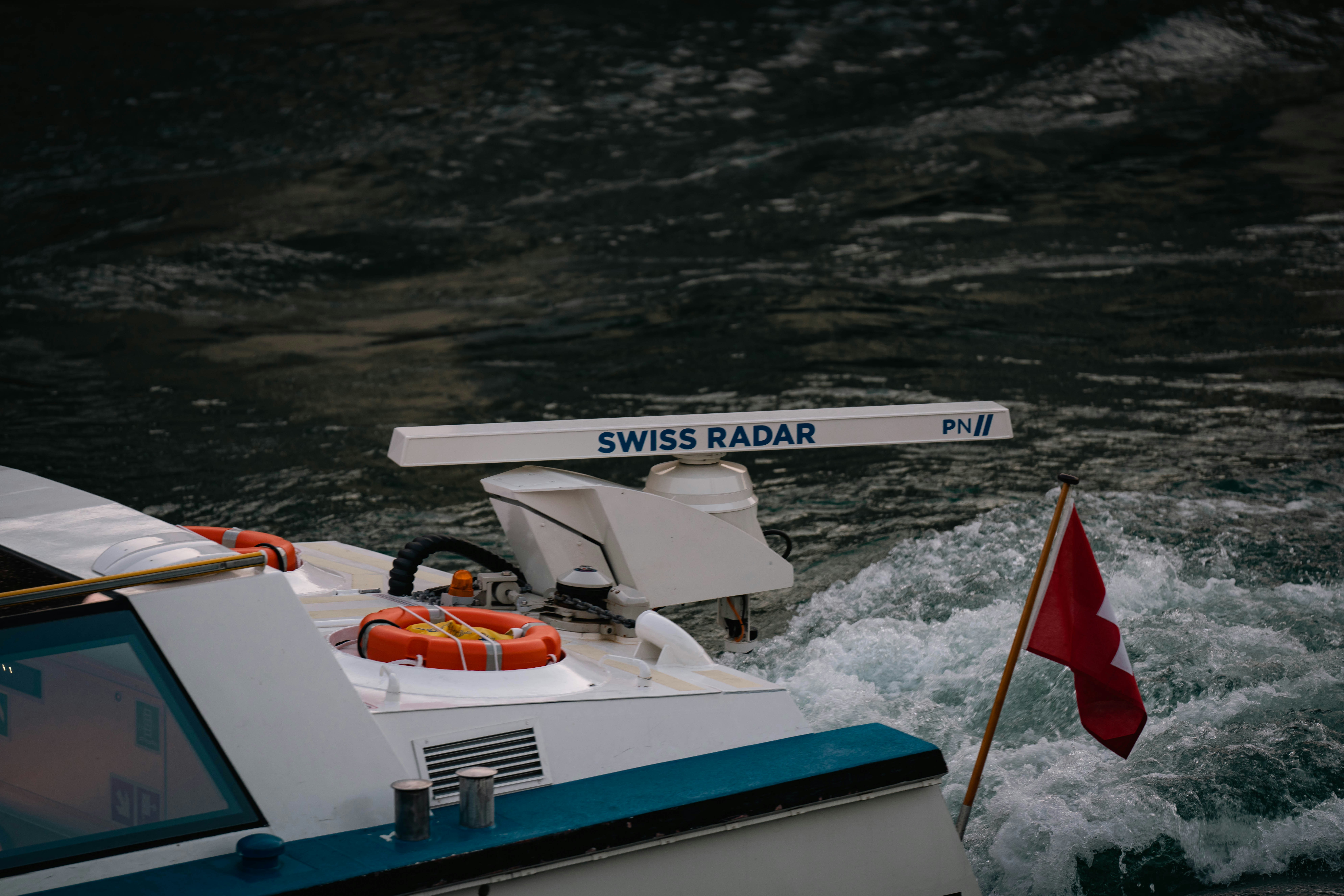 A white and blue boat in the water photo – Free Grey Image on Unsplash