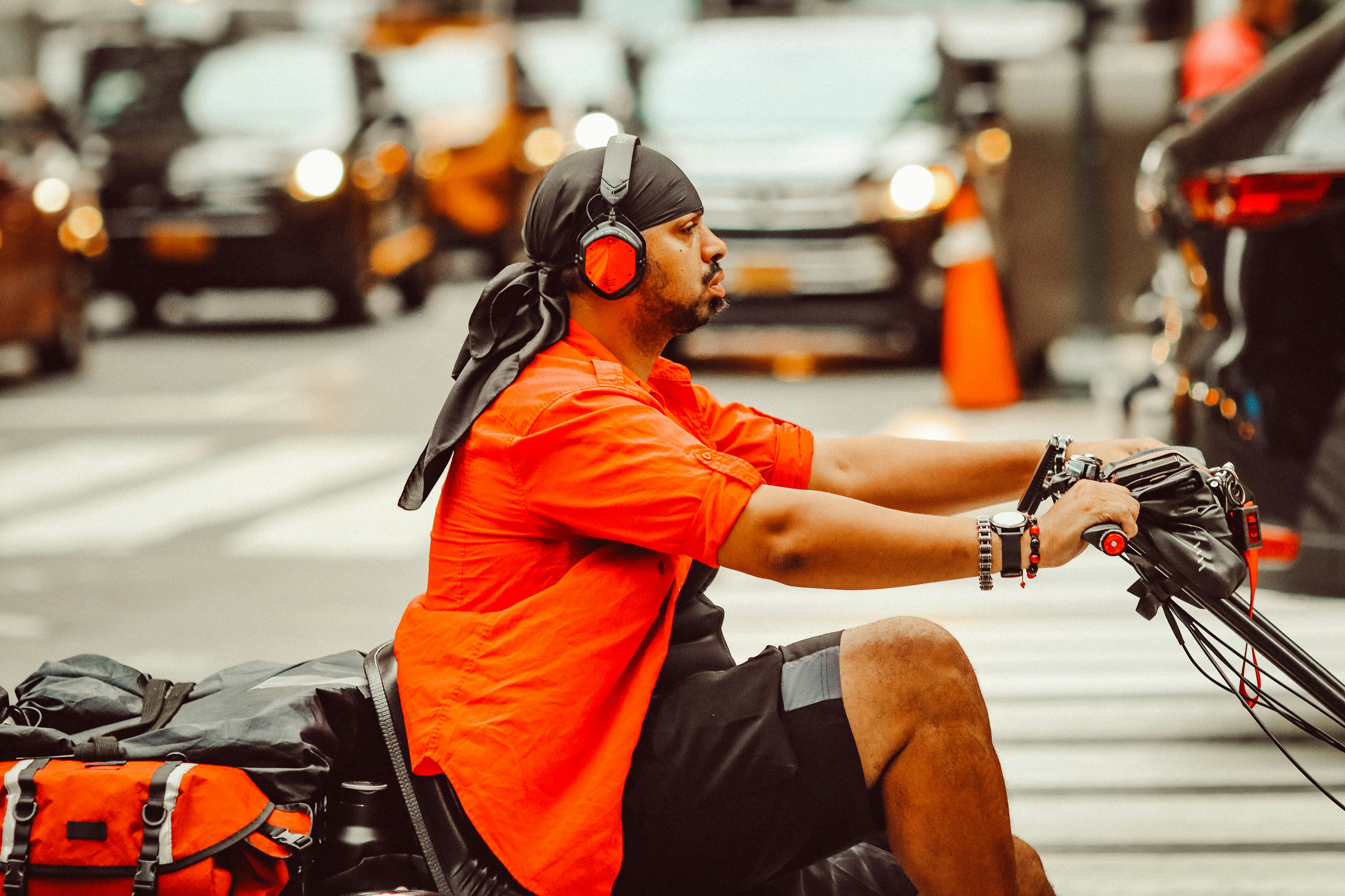 City Rider in Orange: A Street Portrait of Focus and Motion