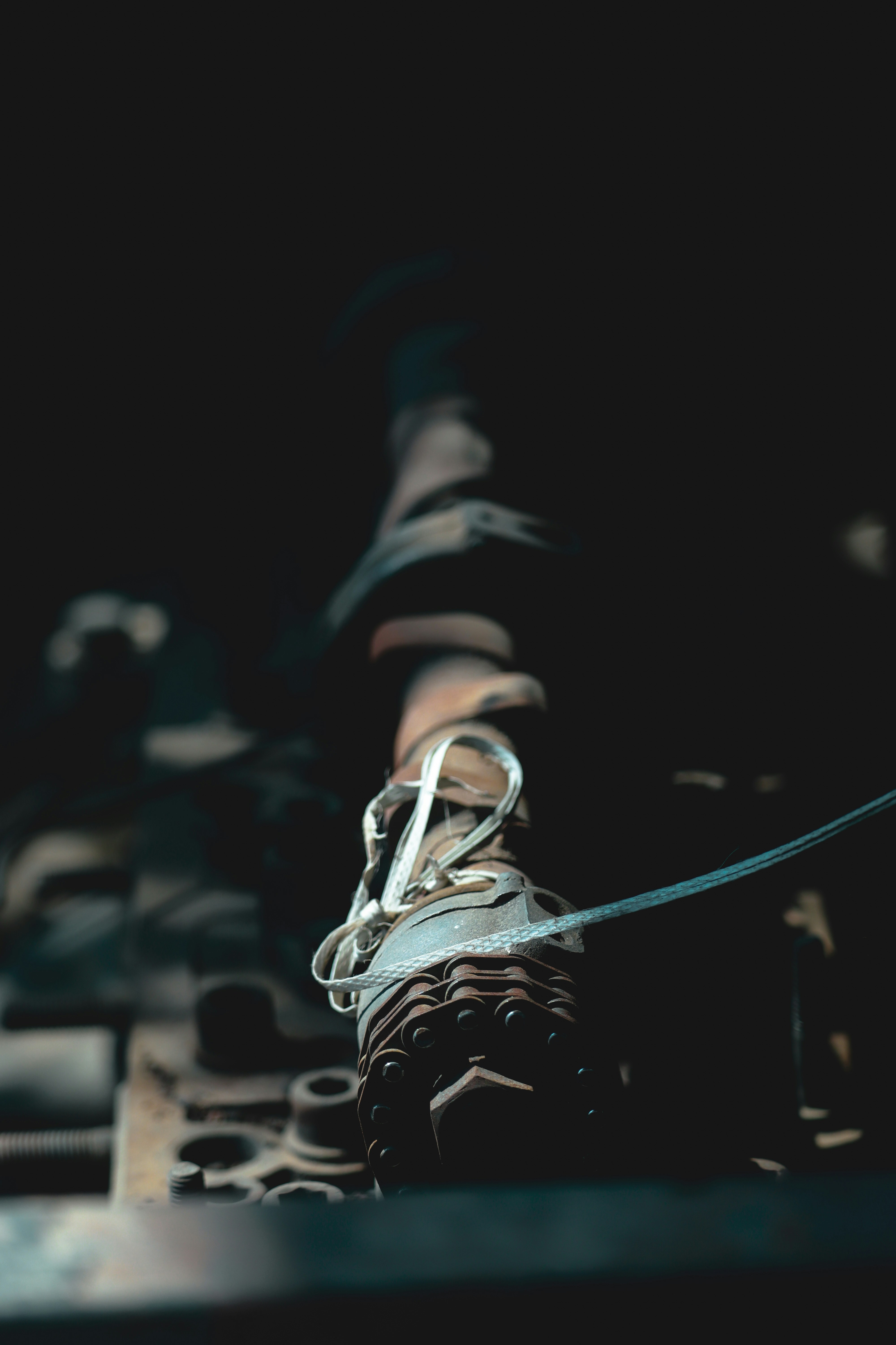Lace and Steel: A Close-Up of a Boot Anchored to Rust