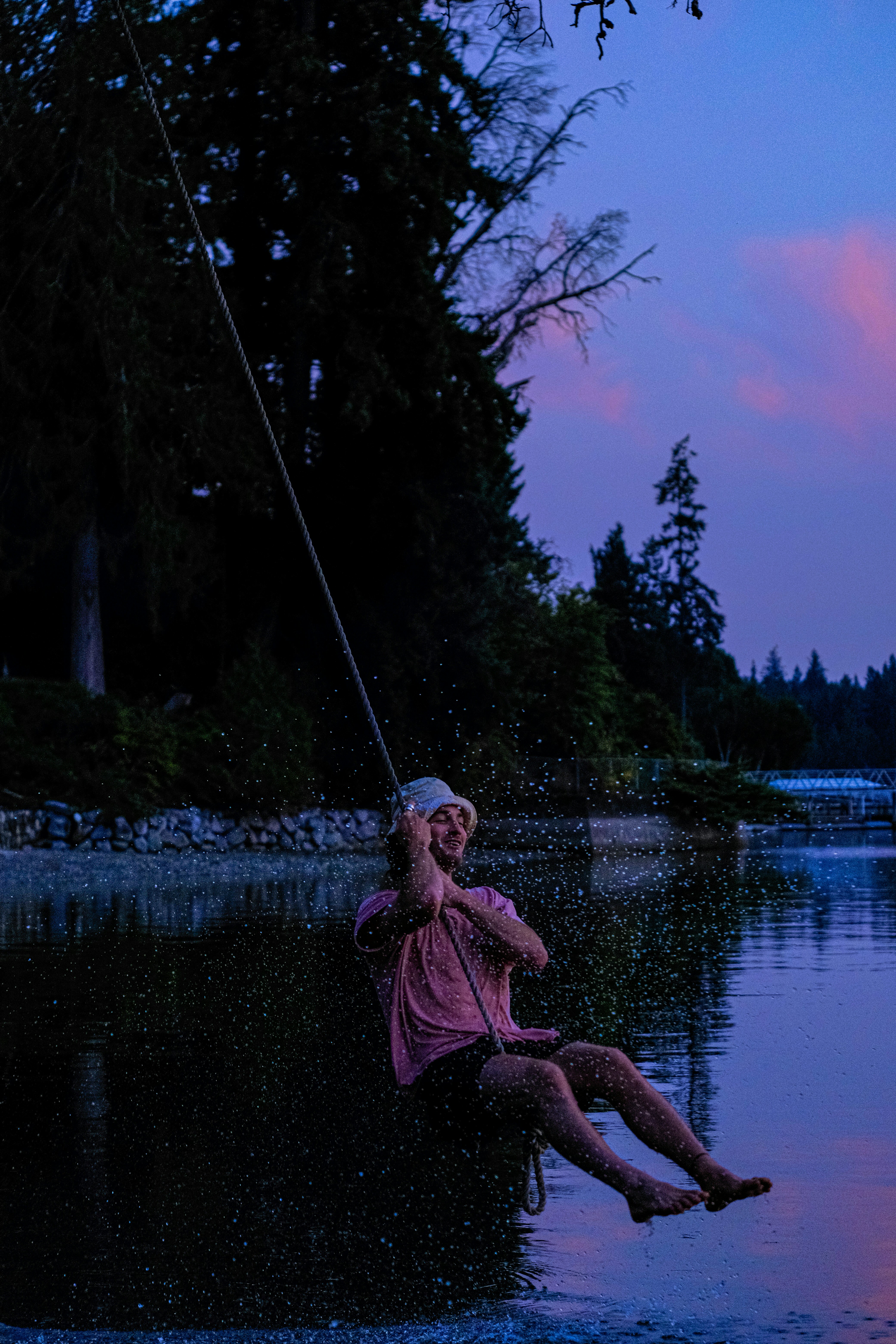 A woman is swinging on a rope in the water photo – Free Travel pic ...