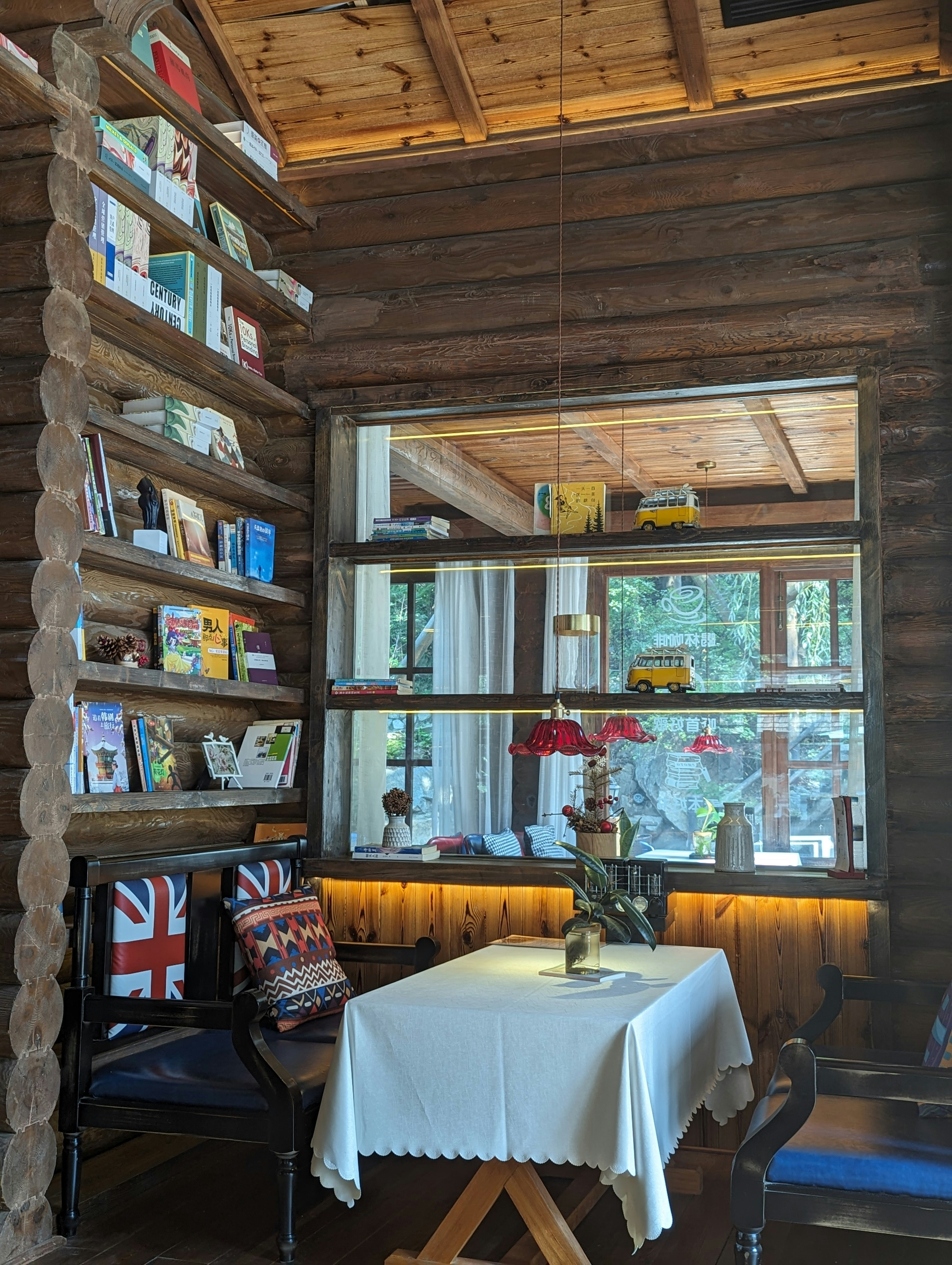 Sunlit Table in a Log-Cabin Café Framed by Bookshelves