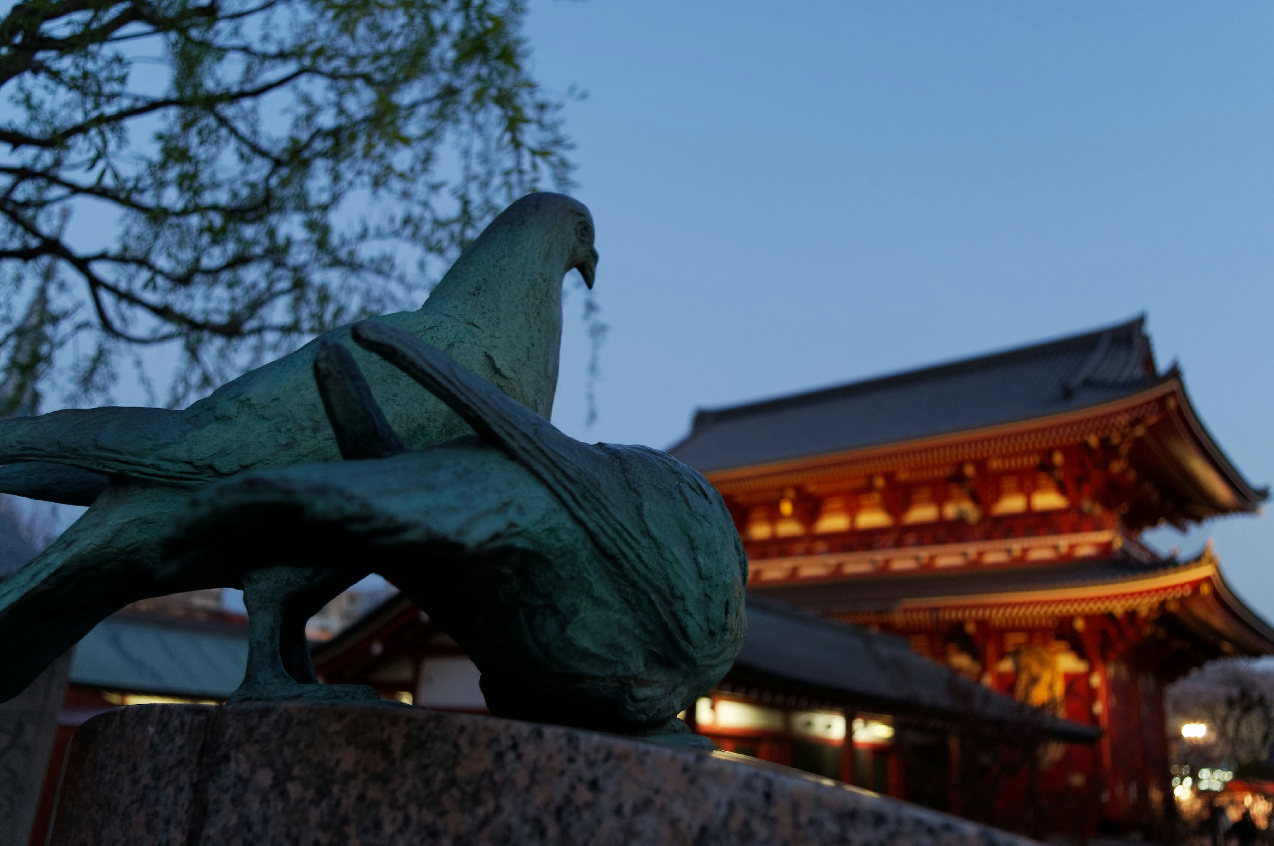 Bronze Sentinel at Dusk: Lantern-lit Shrine in a Courtyard