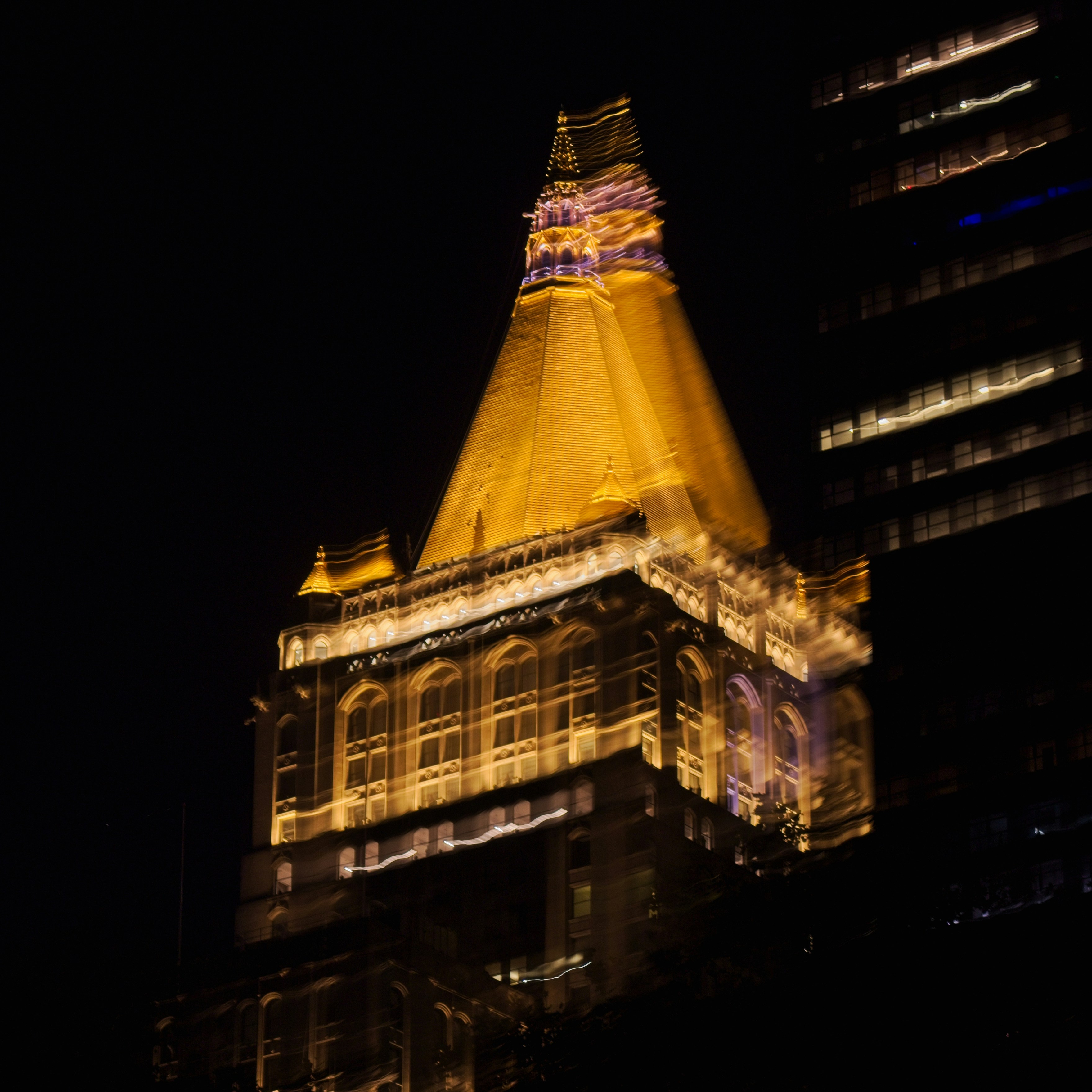 Golden Spire in Night Glass: A Blur-Swept City Portrait